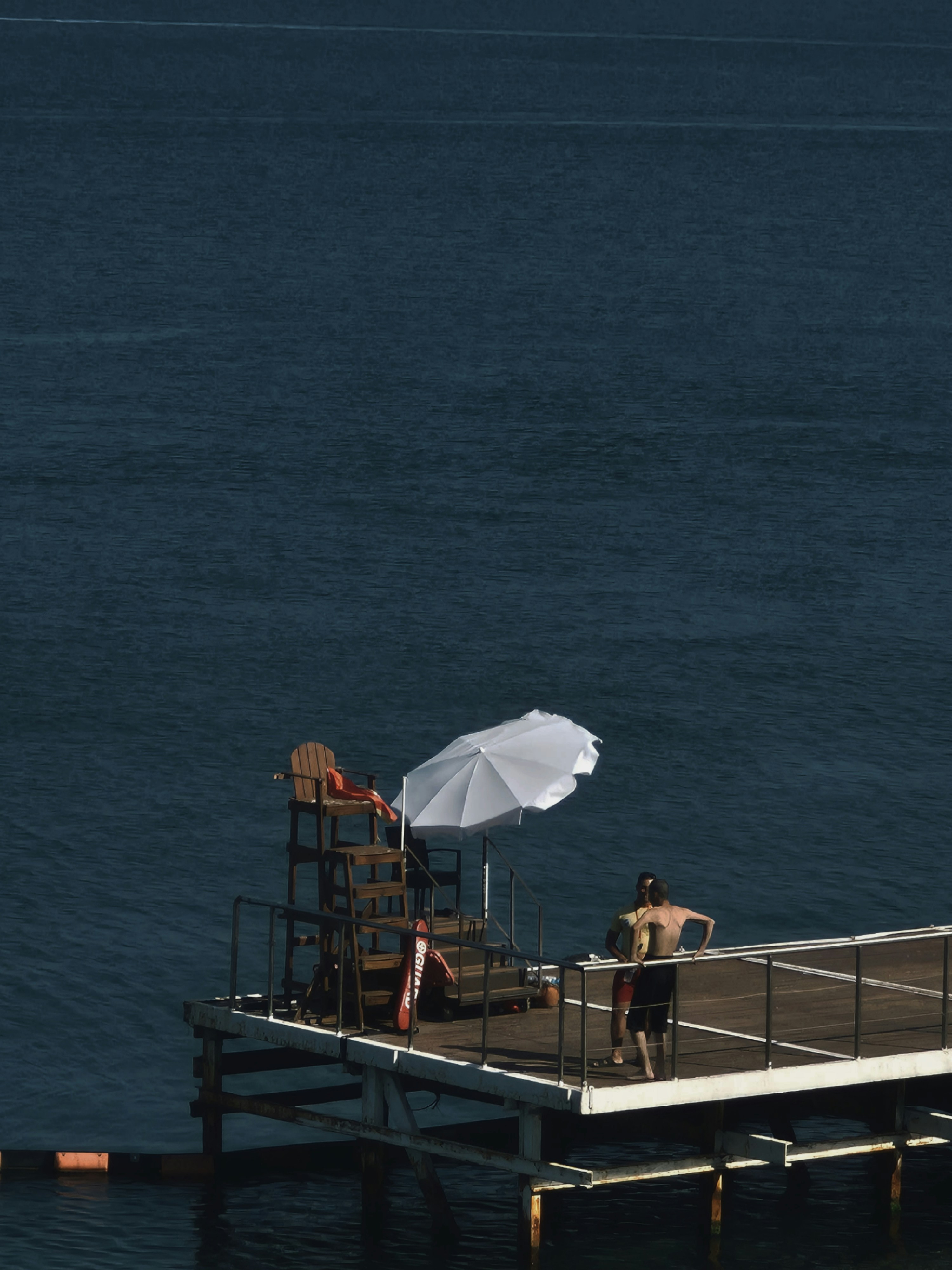 Paragliding Parapet: A Quiet Lifeguard Pier by the Sea