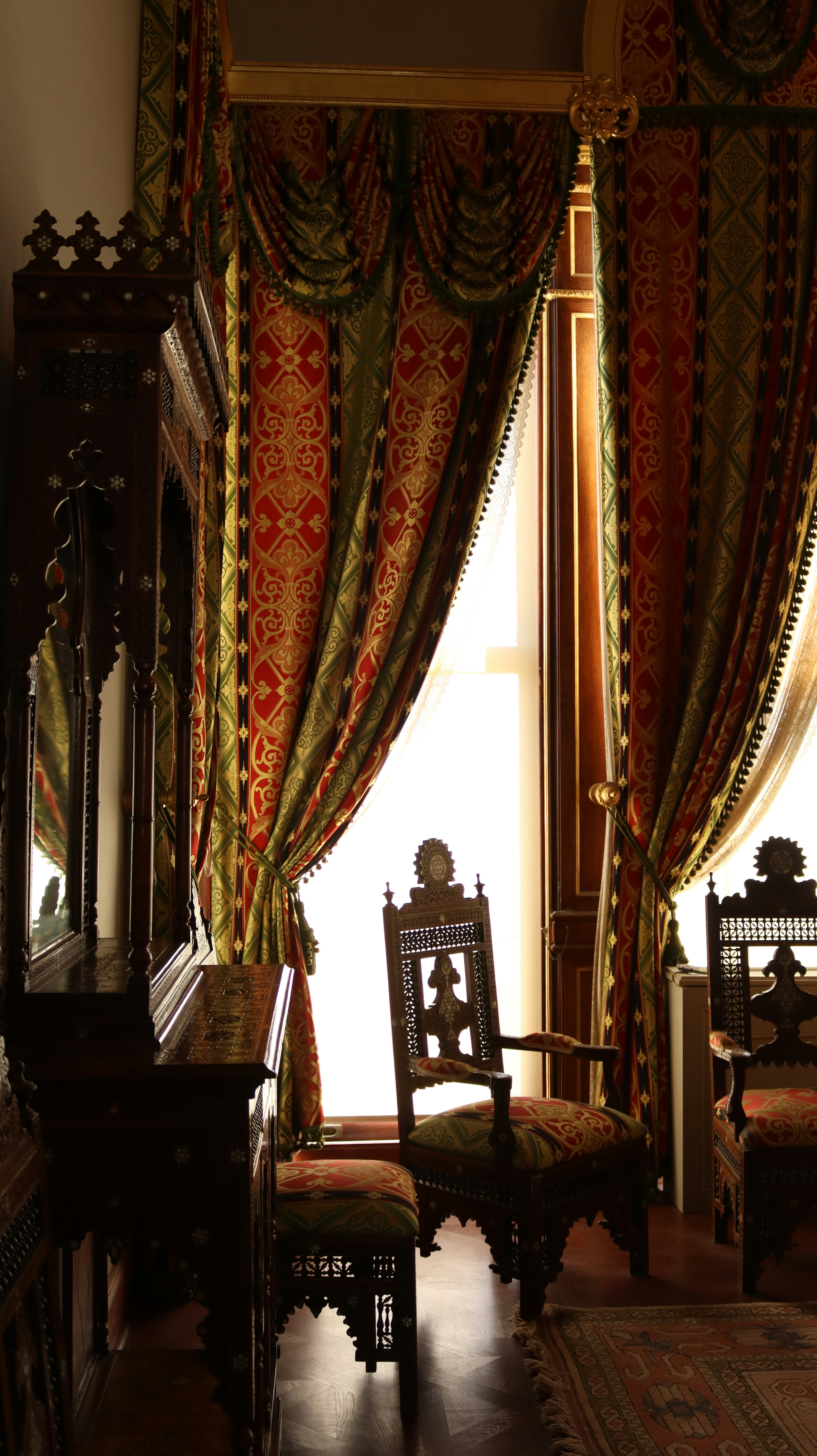 Ornate Chamber: Velvet Drapes Framing Classical Carved Chairs