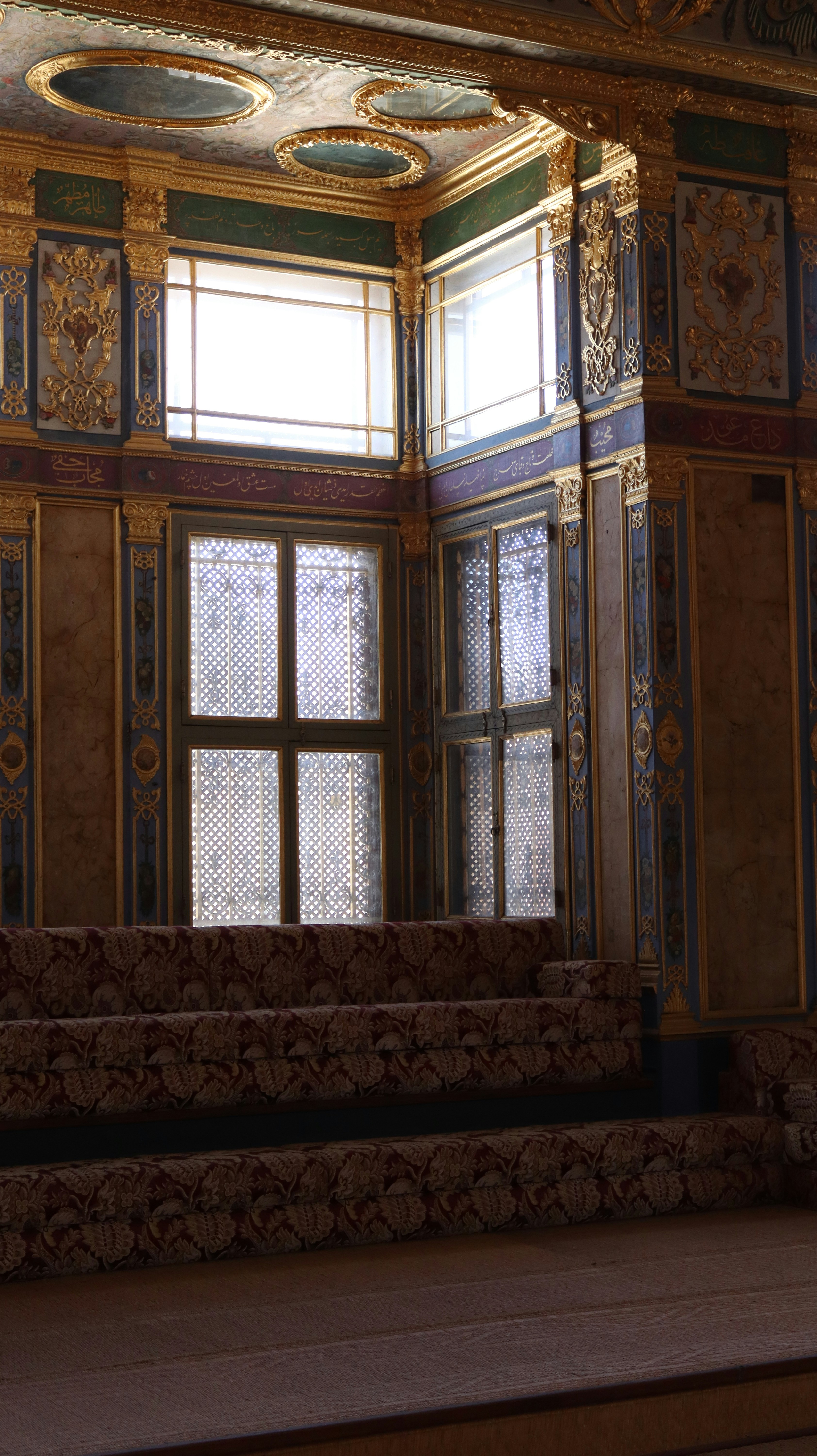 Sunlit windows and gilded panels in a royal salon