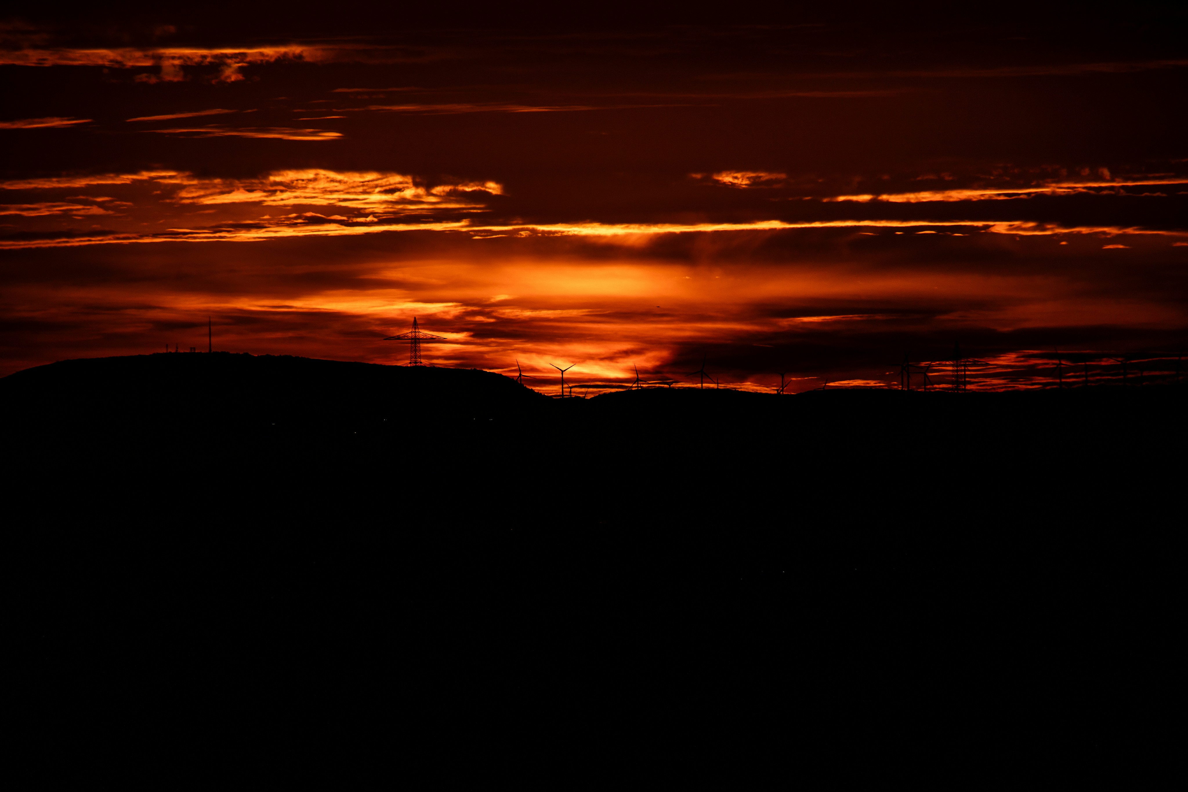 Dawn’s Ember: Silhouette of Horizon with Fiery Sky