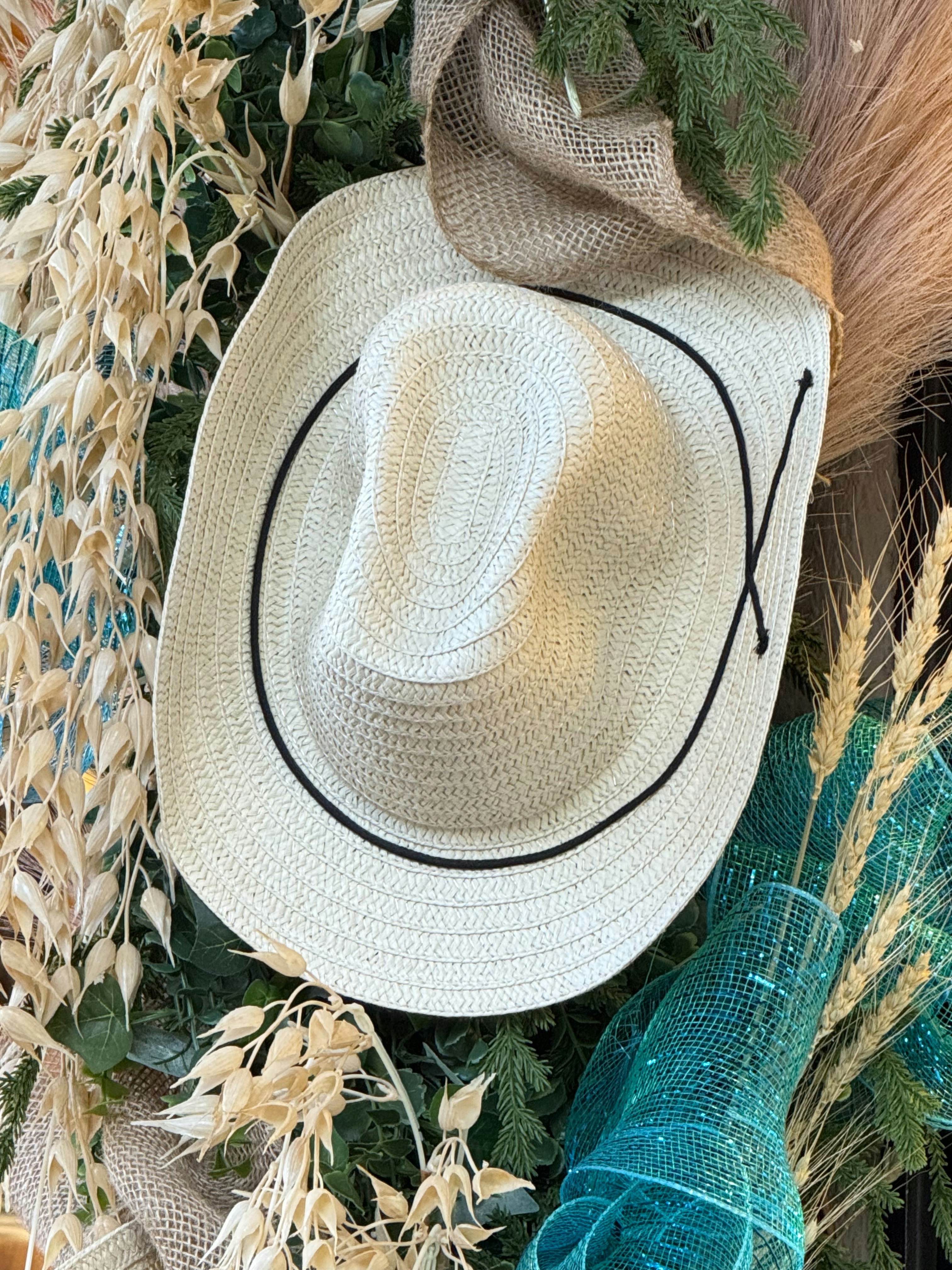 Straw Hat Among Dried Flora and Green accents