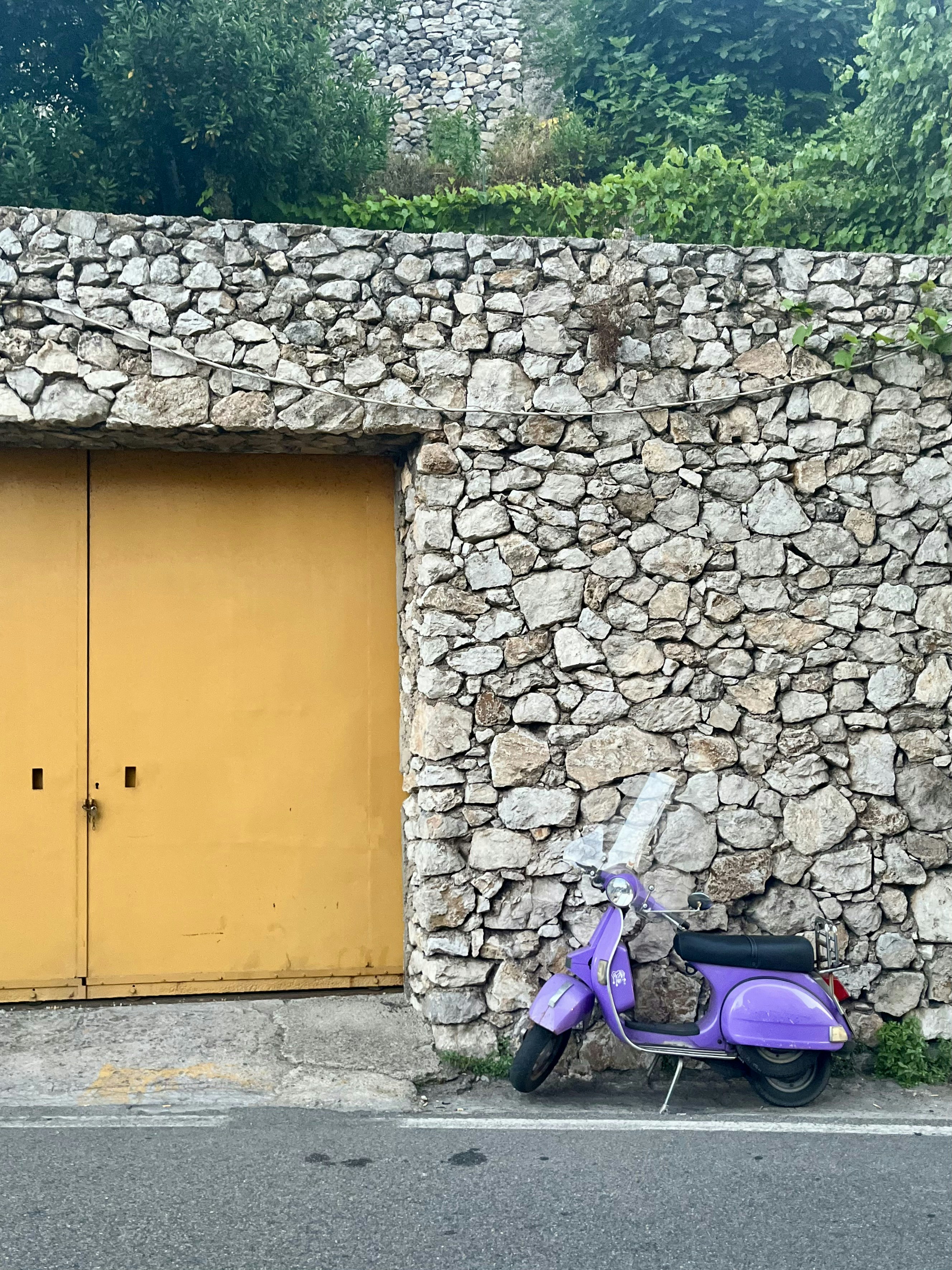 Purple Vespa by the Stone Wall