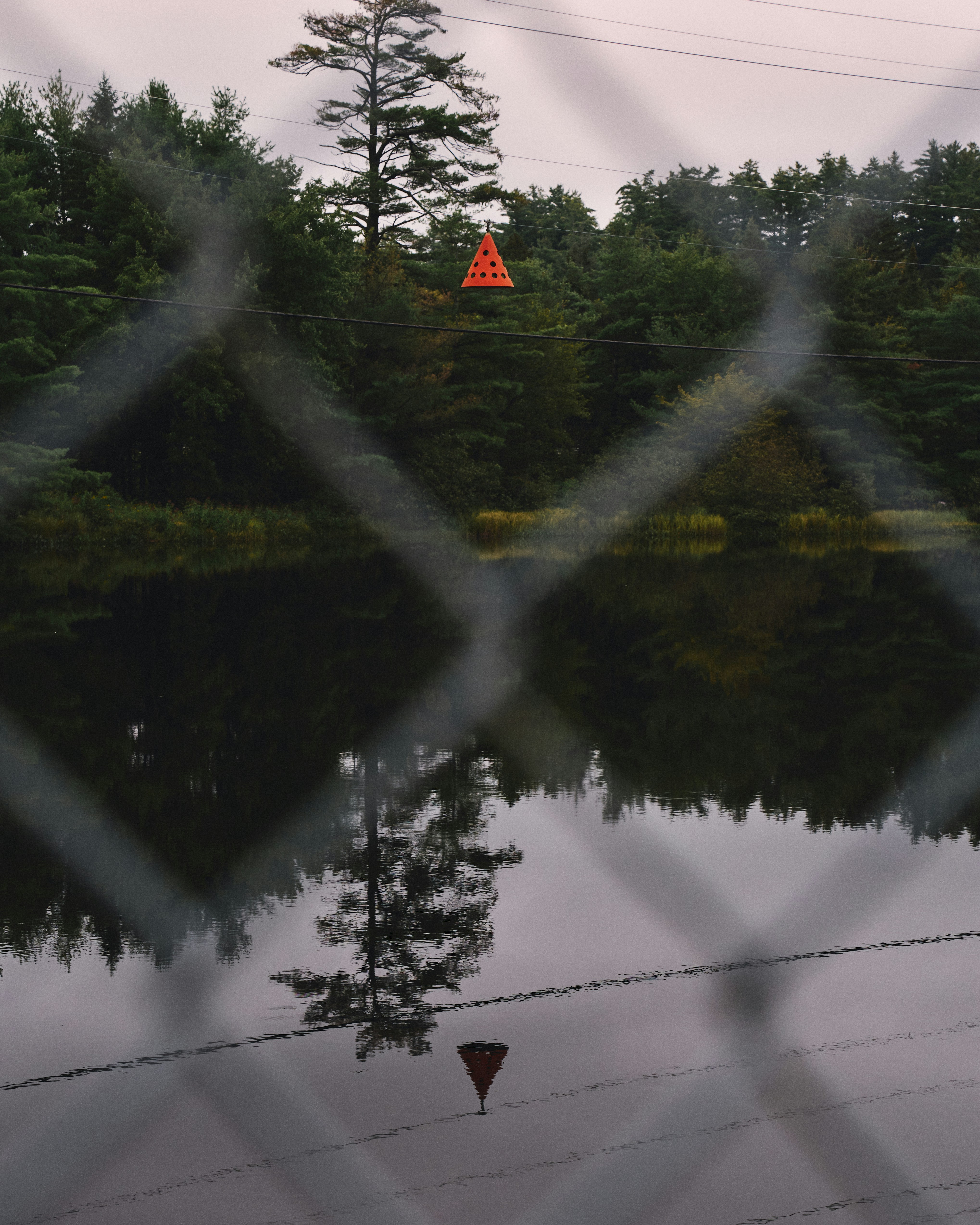 Hidden Triangle of Red Beacon Over Calm Mirror