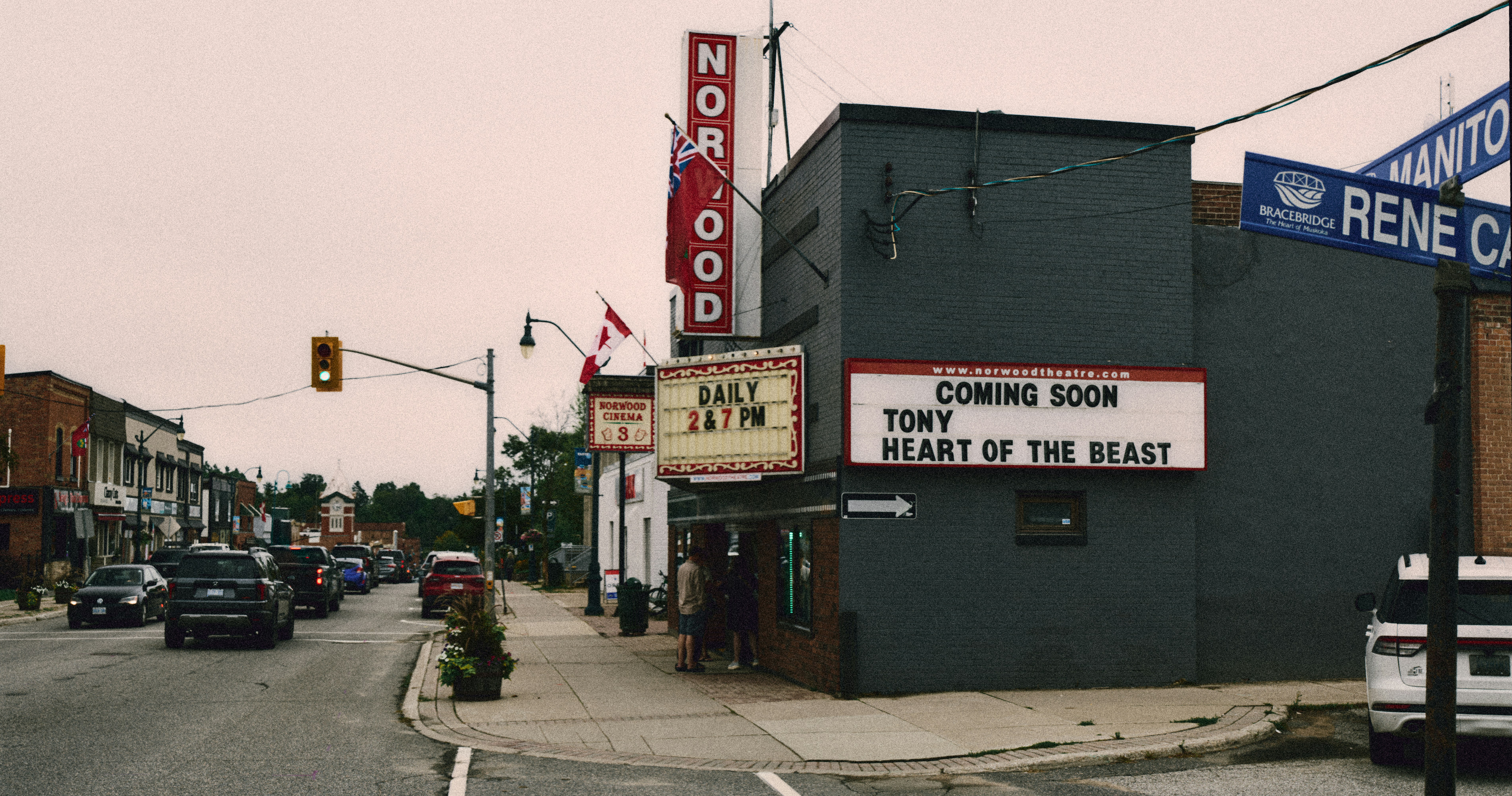 Neon Theater Sign and Urban Corner under Soft Dusk