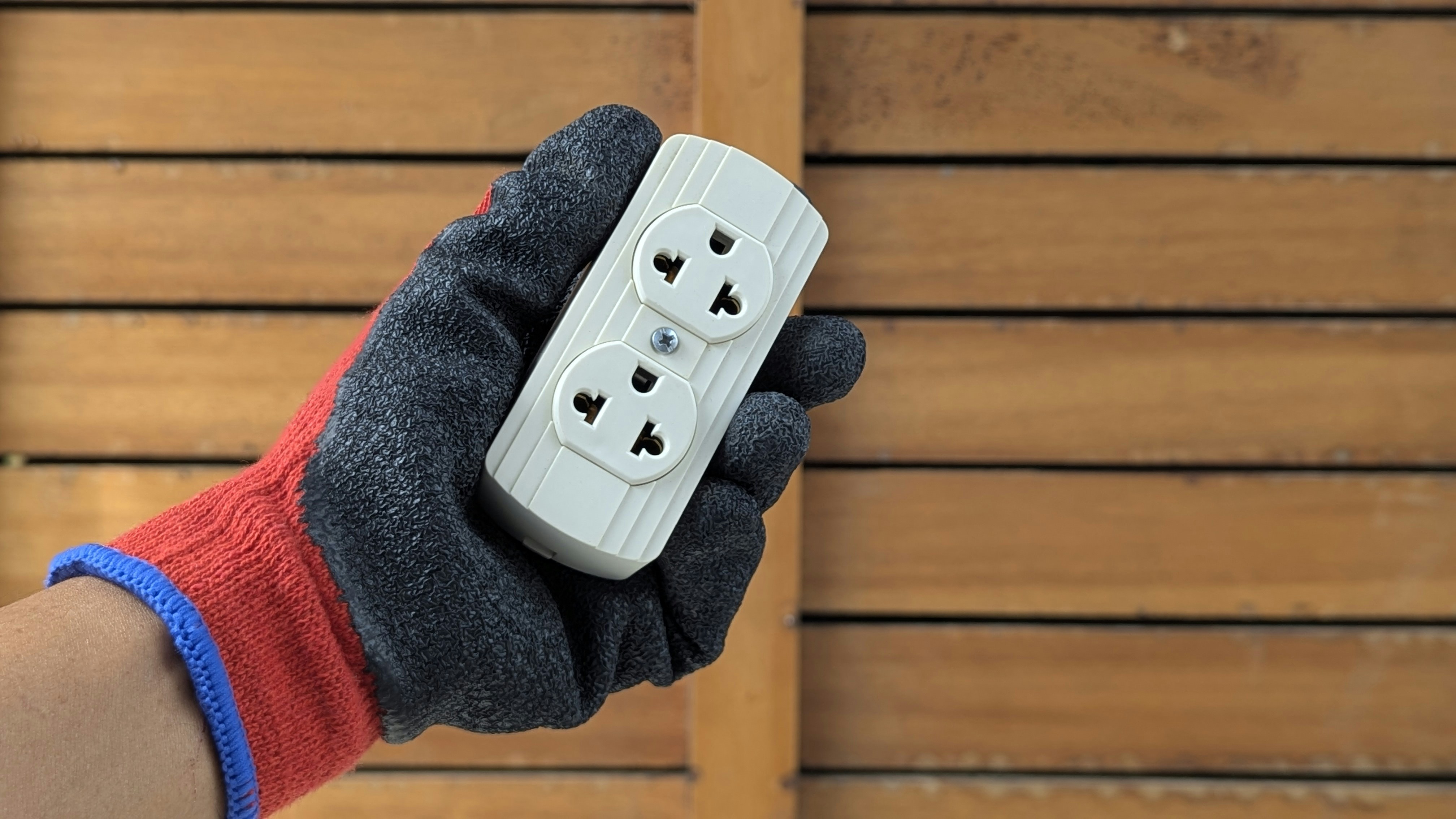 Grip and Grounding: A Power Strip in a Gloved Hand