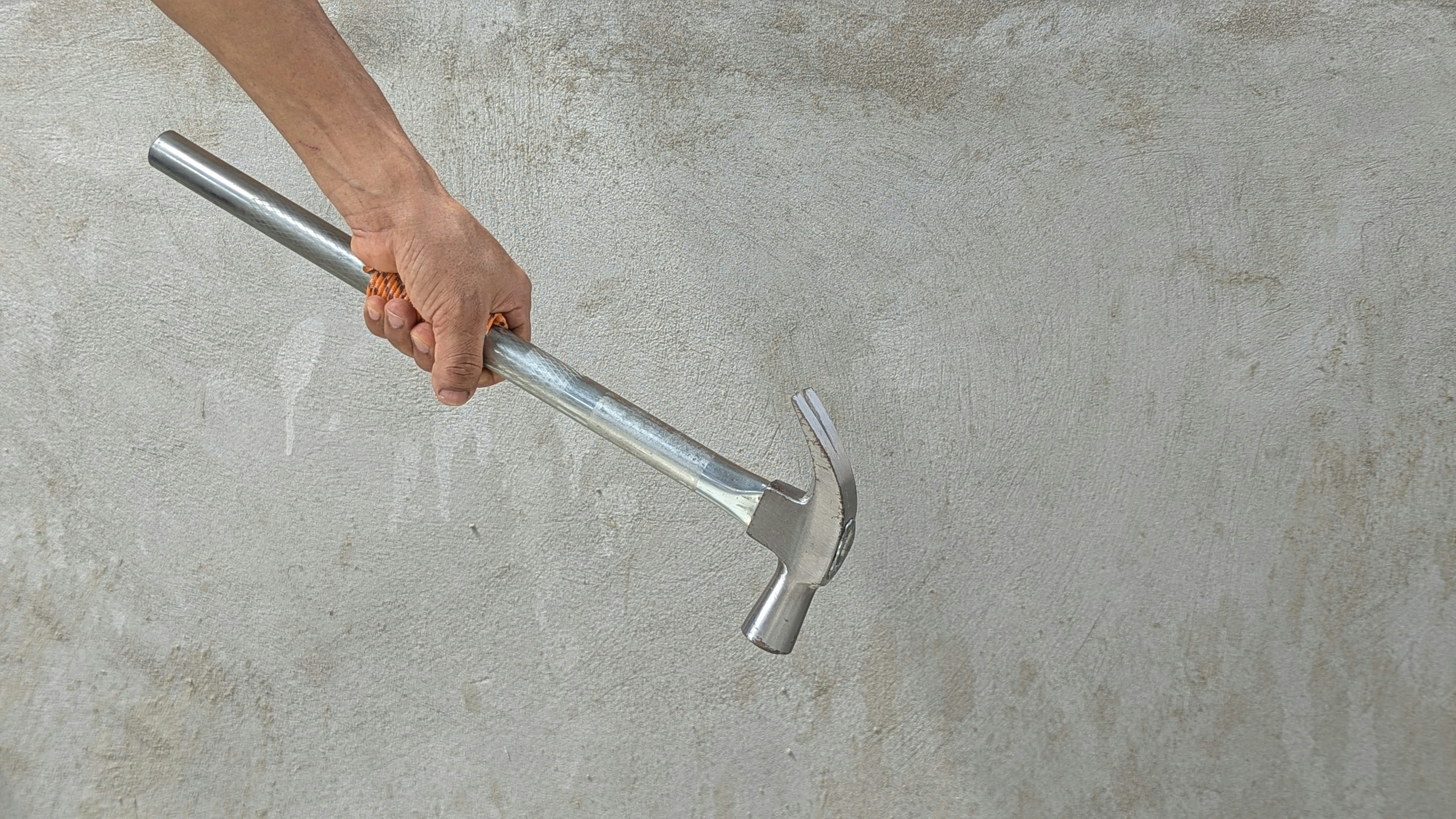 Grip and Hammer: A Handful of Steel in a Concrete Frame