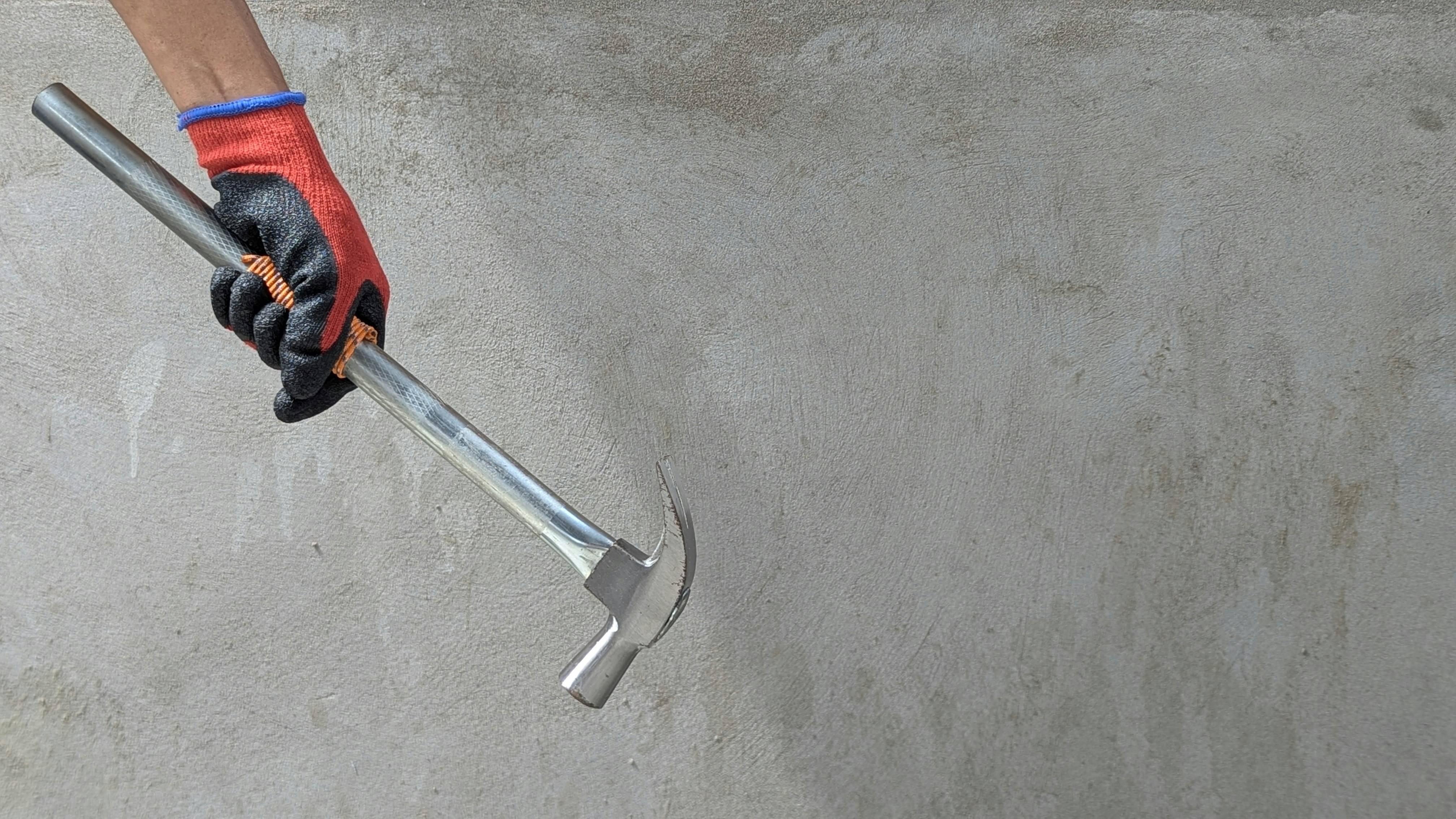 Hammer in hand: precision grip against a rough backdrop