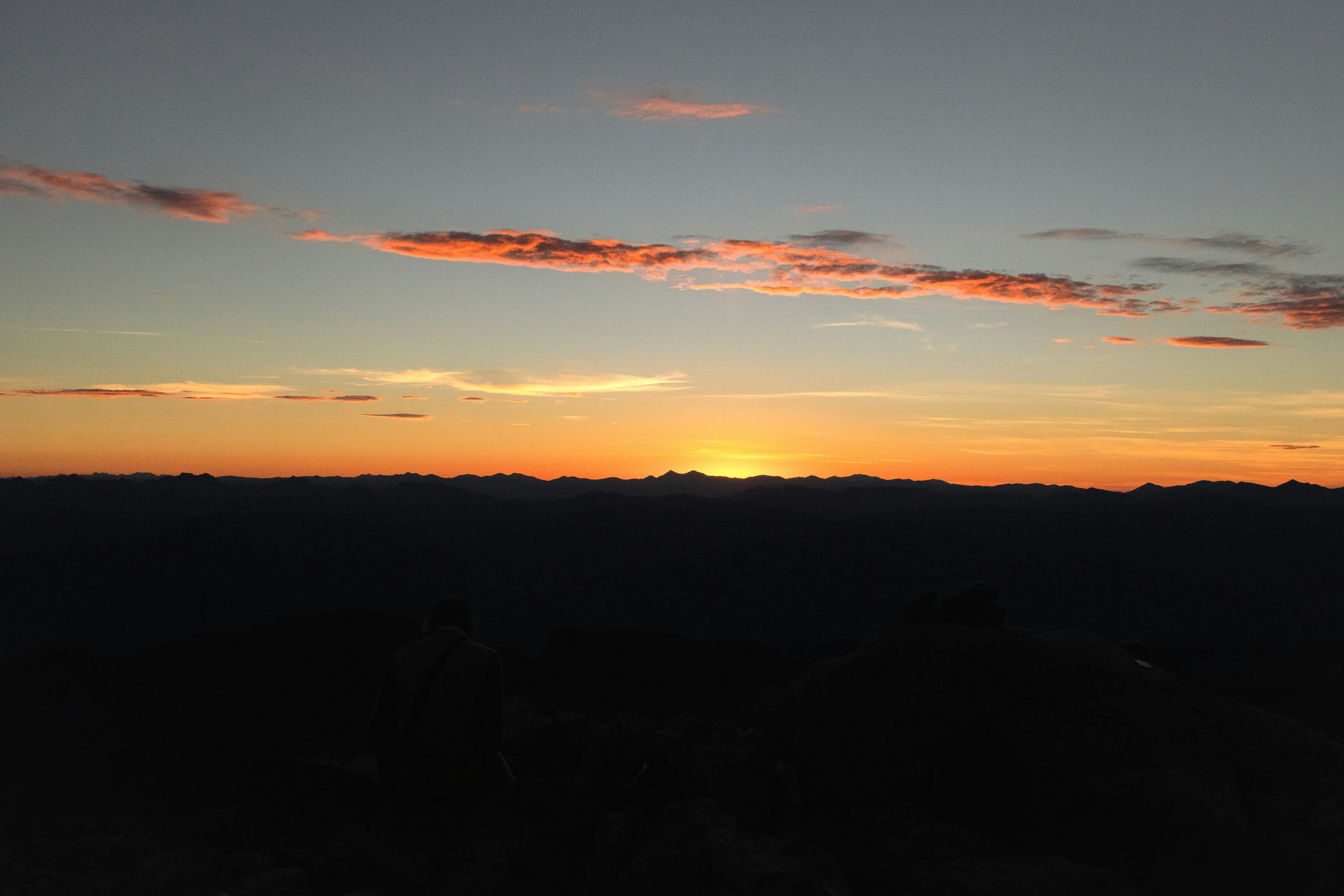 Sunset Summit: Quiet Horizon Beneath a Fiery Sky