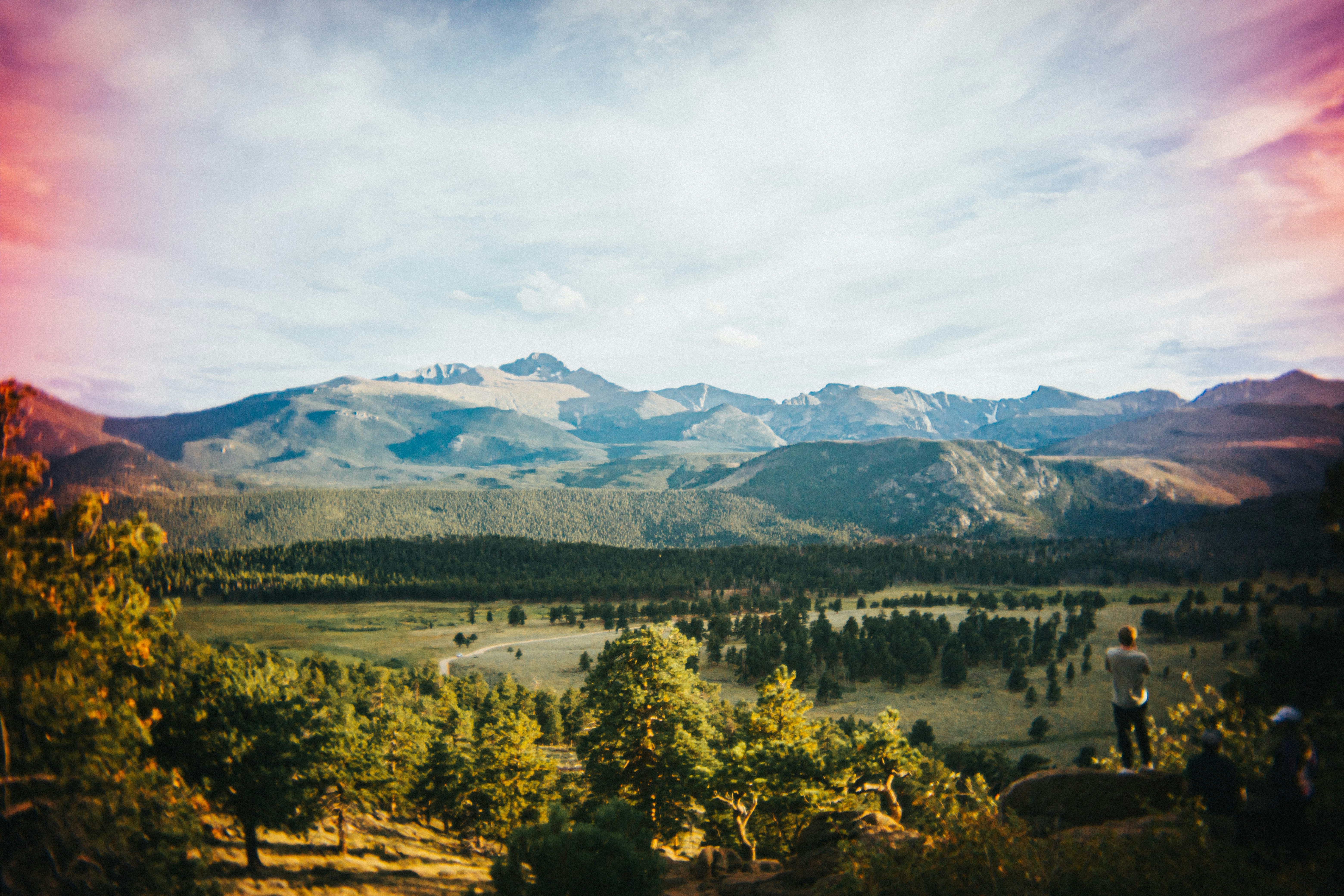 Sunlit Valley with Distant Peaks Under a Velvet Sky
