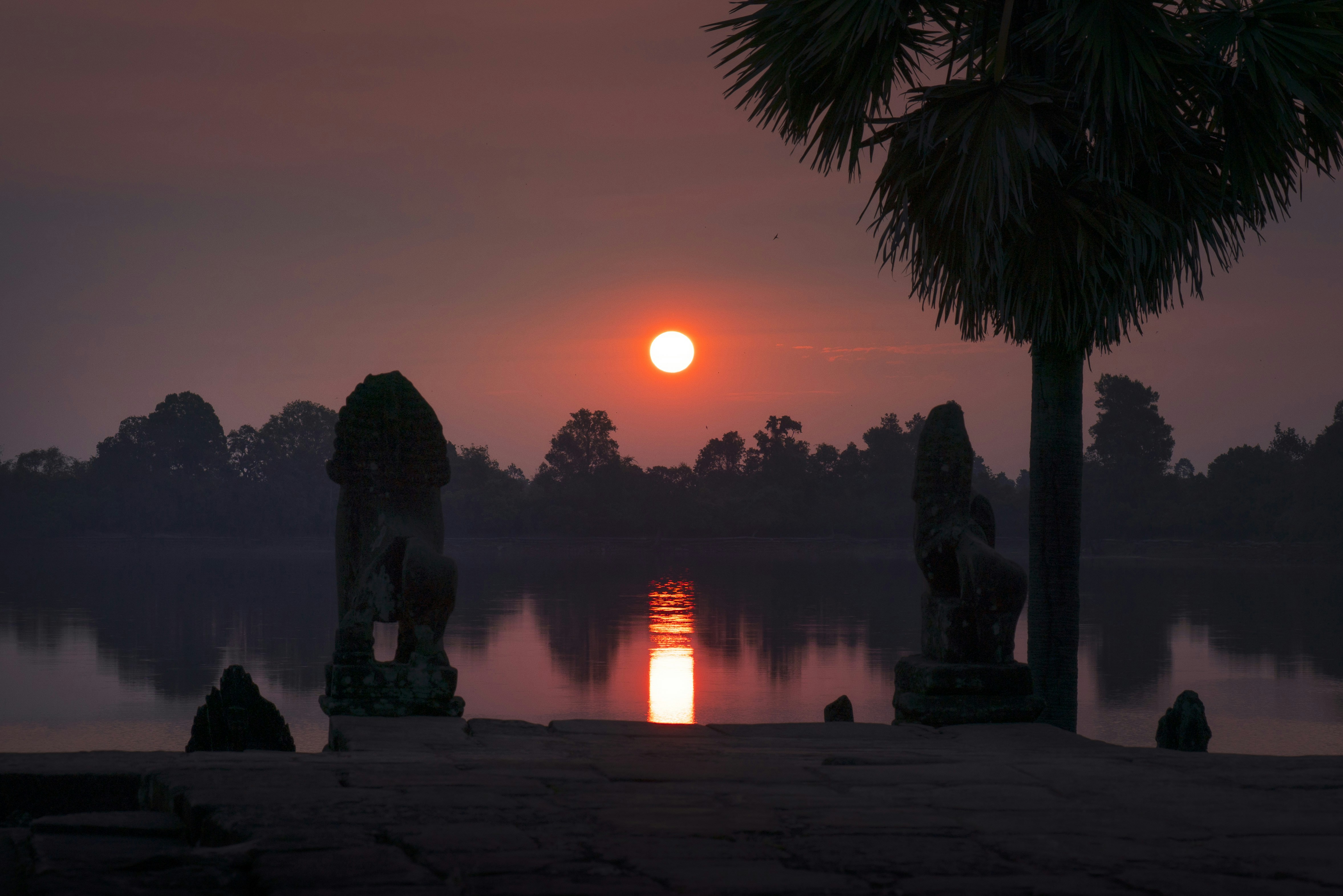 Silhouetted Temple Gates Framed by a Sunset River