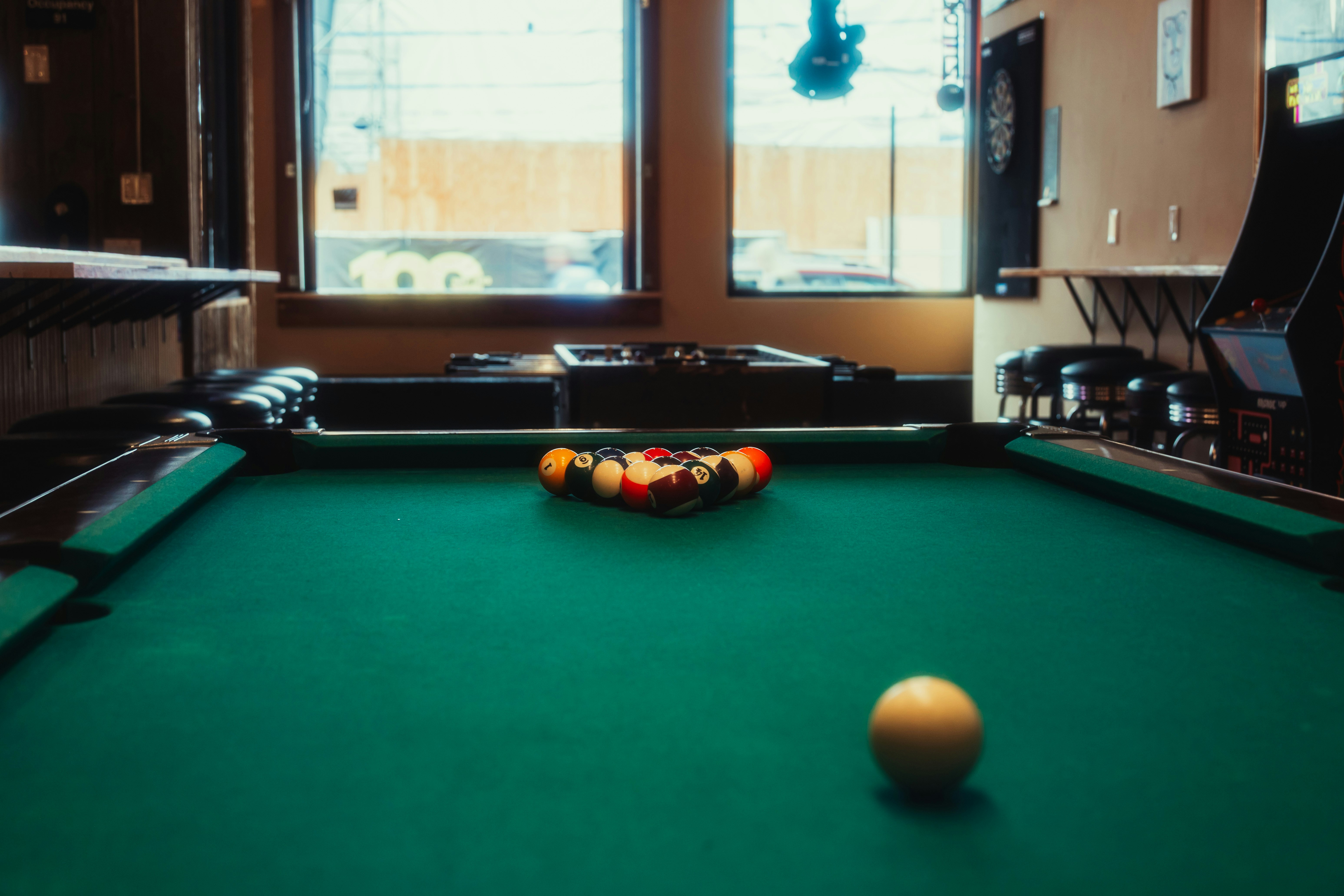 The Final White Orb: A Quiet Break in a Lively Pool Hall