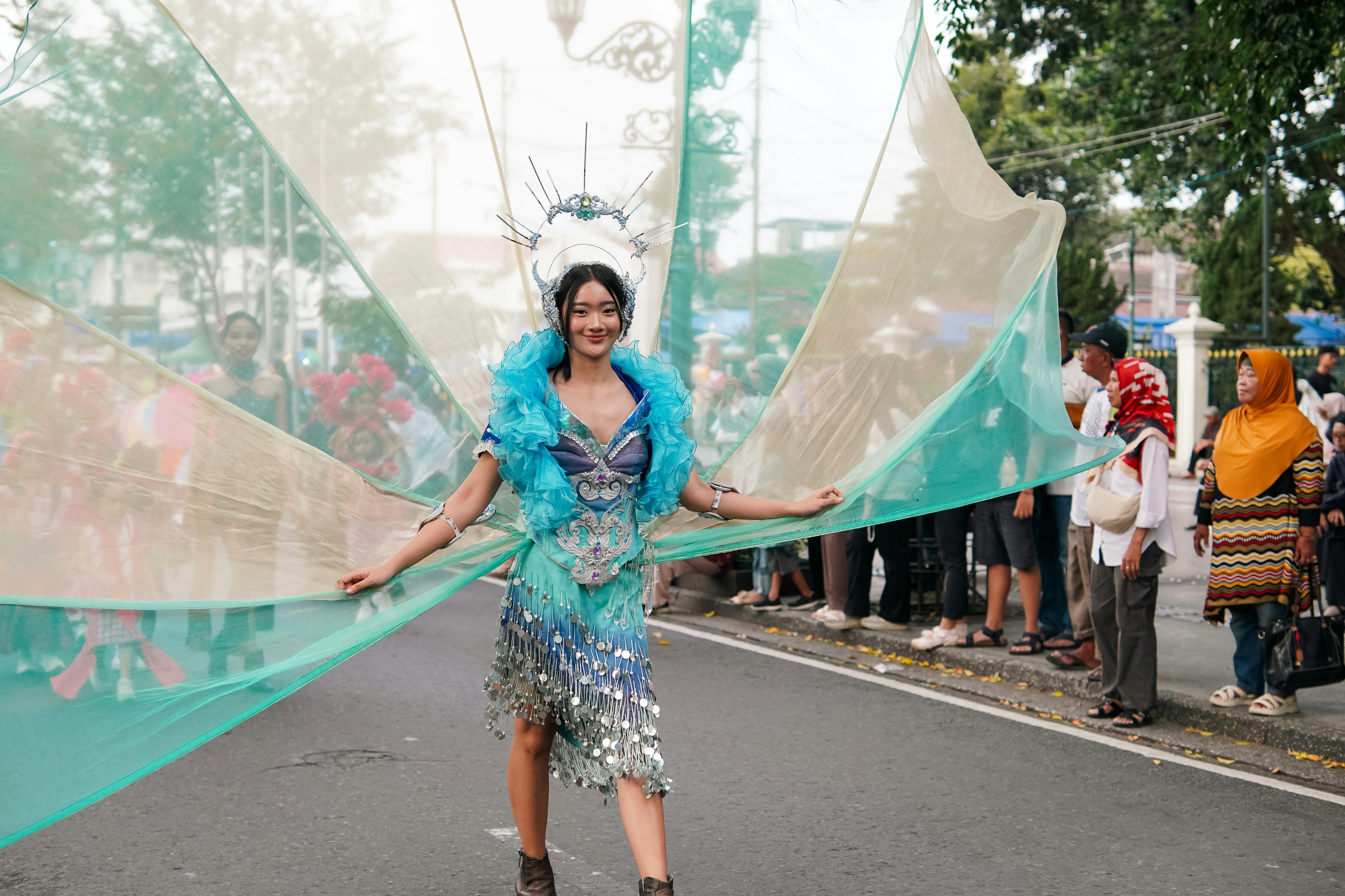 Colorful Parade Spirit: Performer with Turquoise Veiled Wings