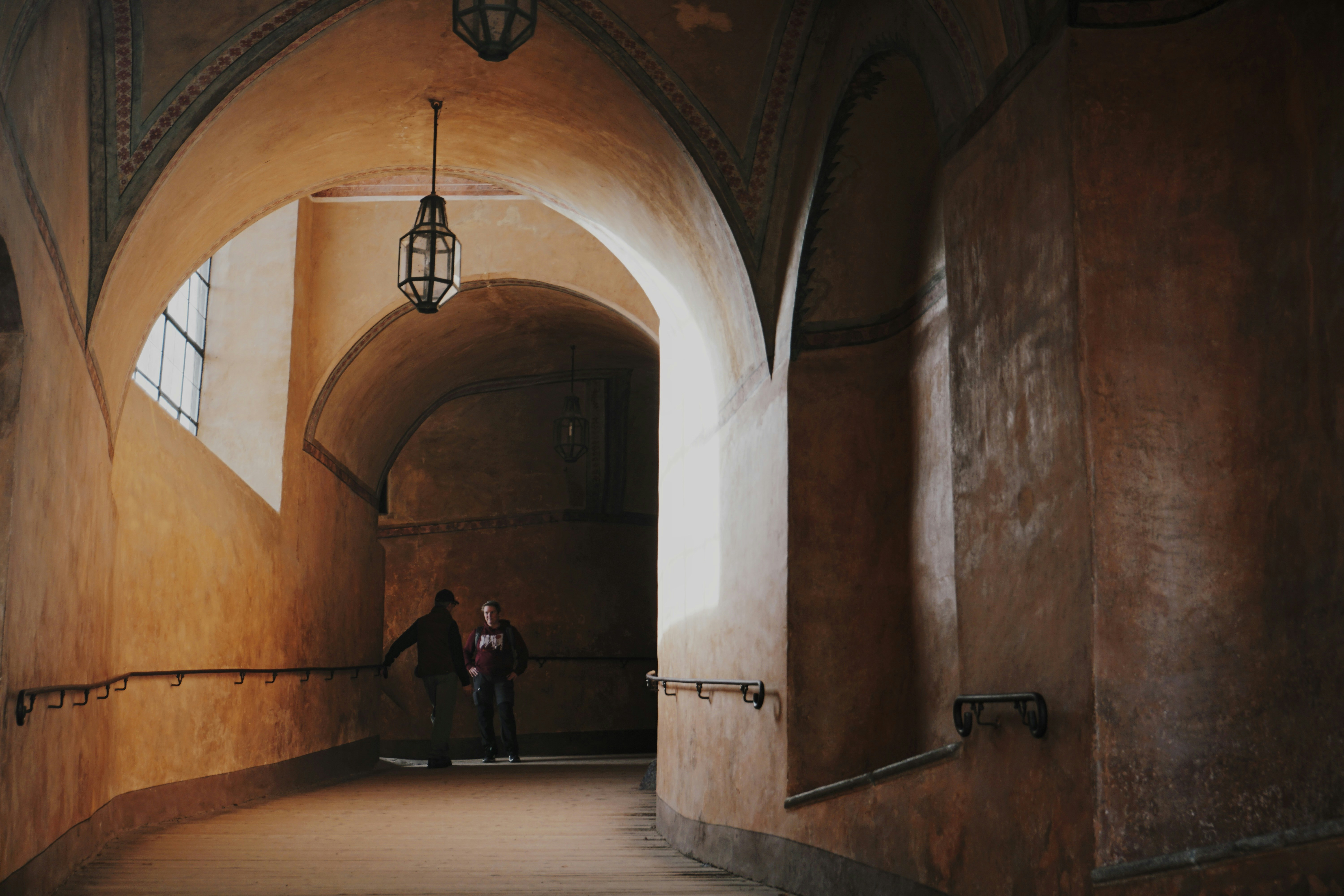 Arched Corridor at Dusk: A Quiet Walk Through Warm Walls