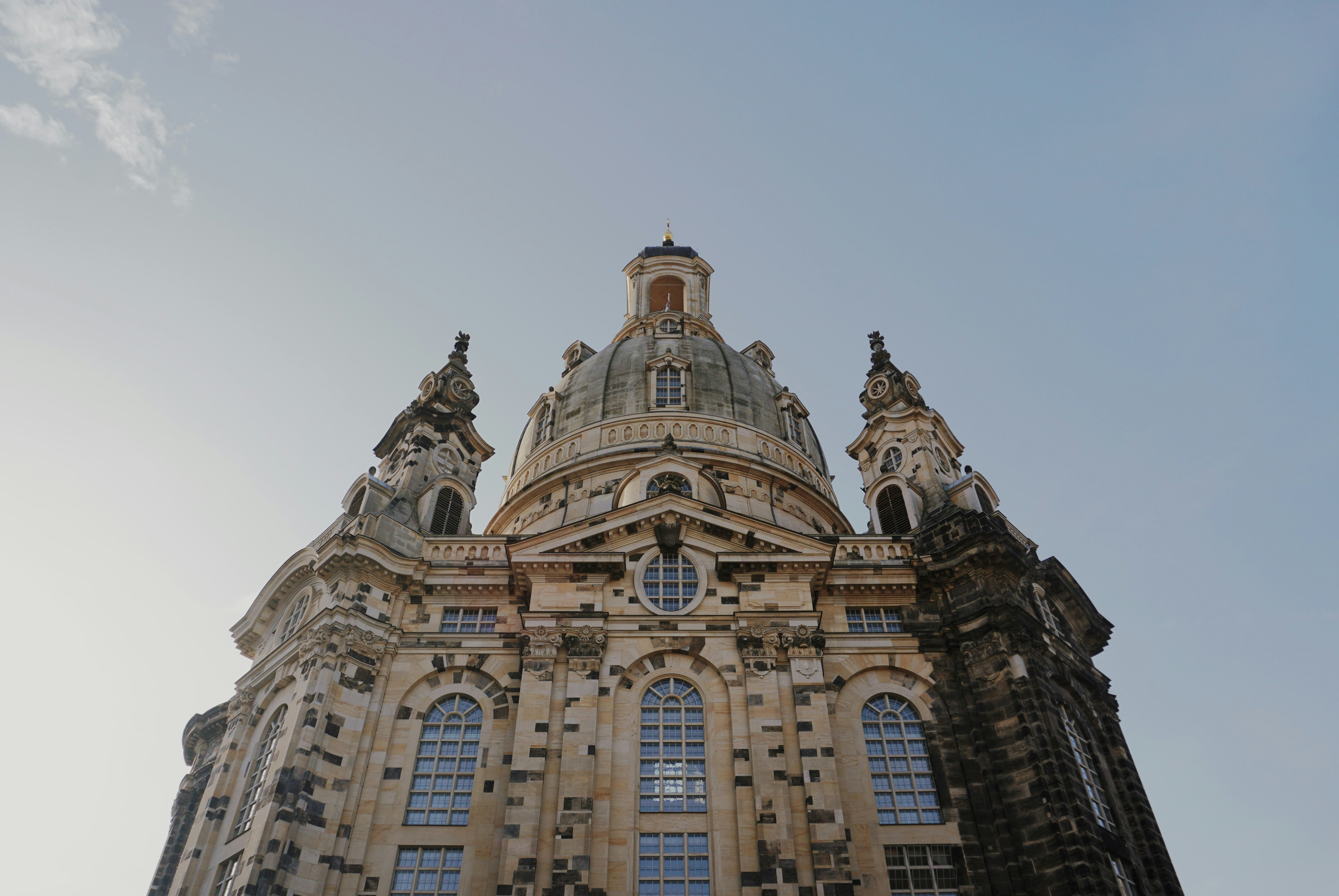 Dome Above Stone Cathedral: A Portrait of Architecture Crowning the Sky