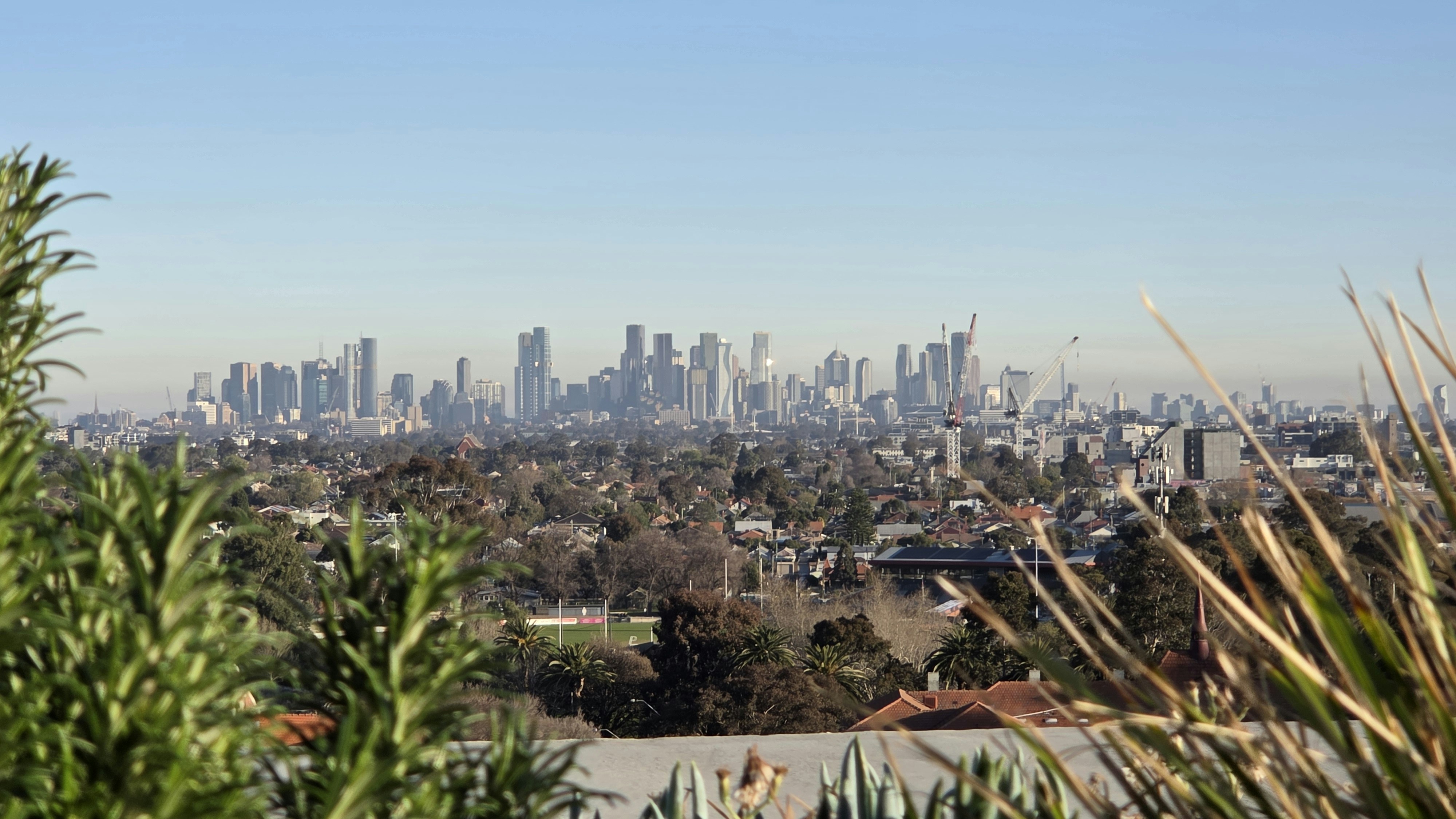 Urban Skyline Emerges Over a Suburban Ridge
