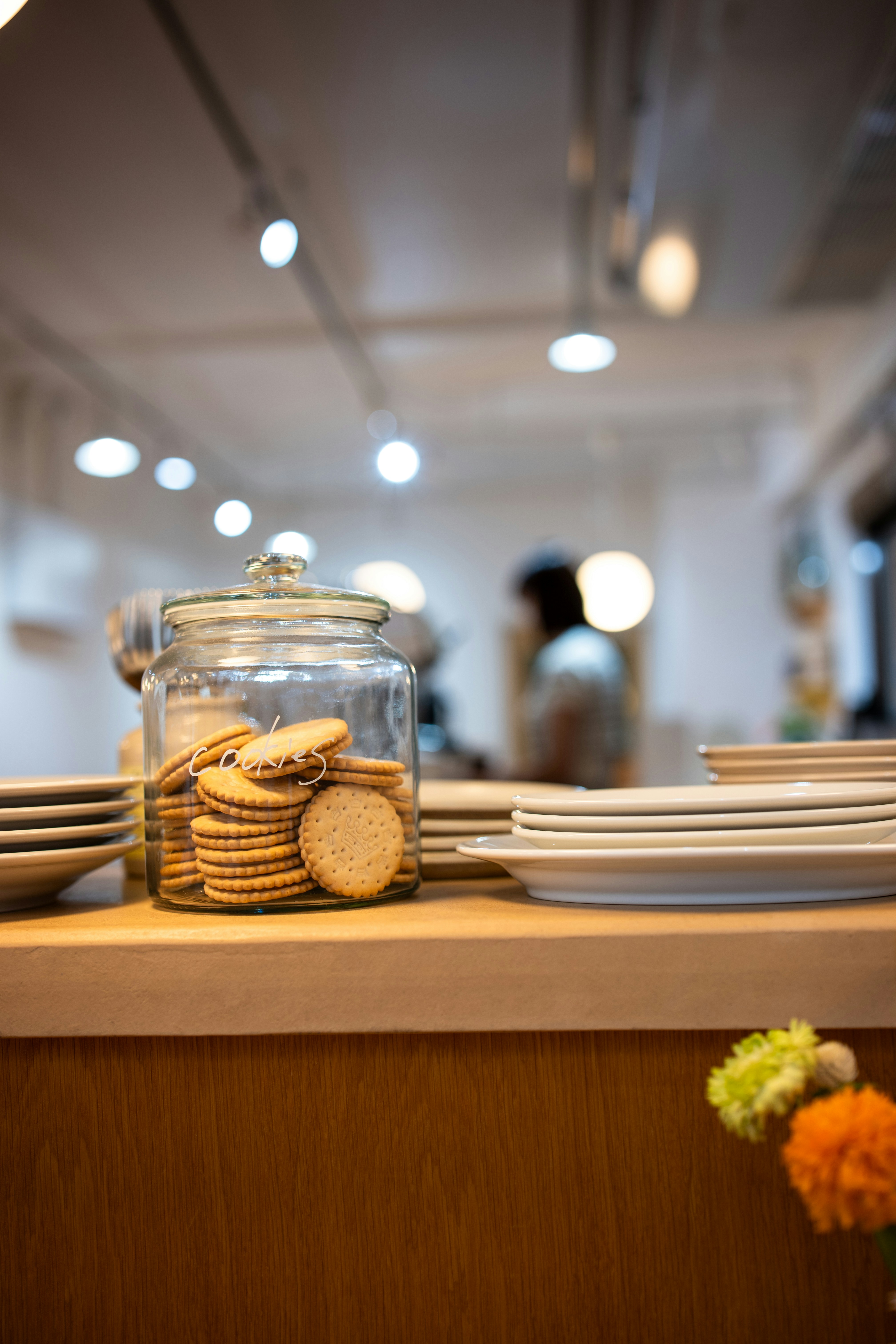 Glass jar of cookies as the centerpiece of a cozy cafe scene