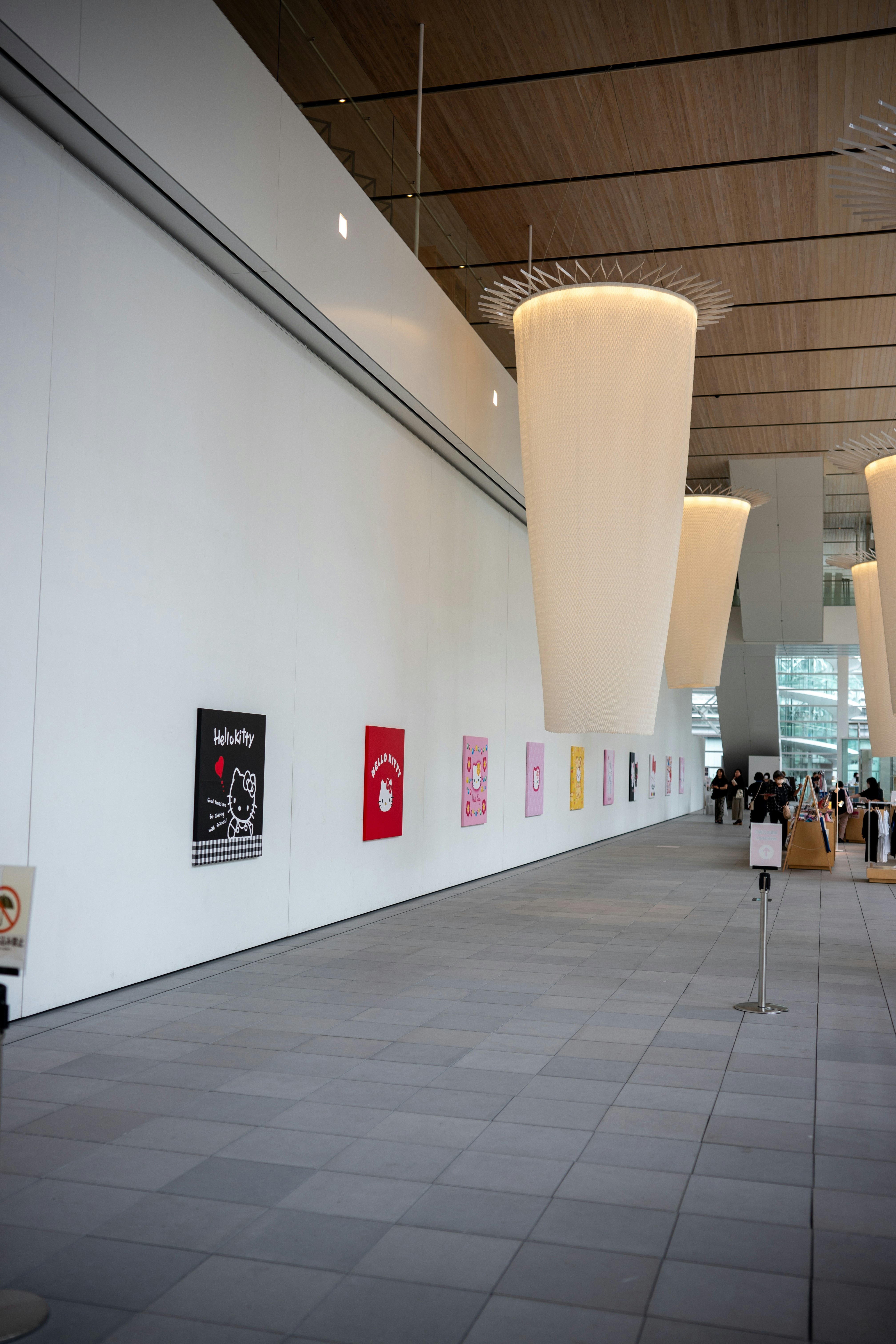 Gallery Hallway with Oversized Cylindrical Light Fixtures