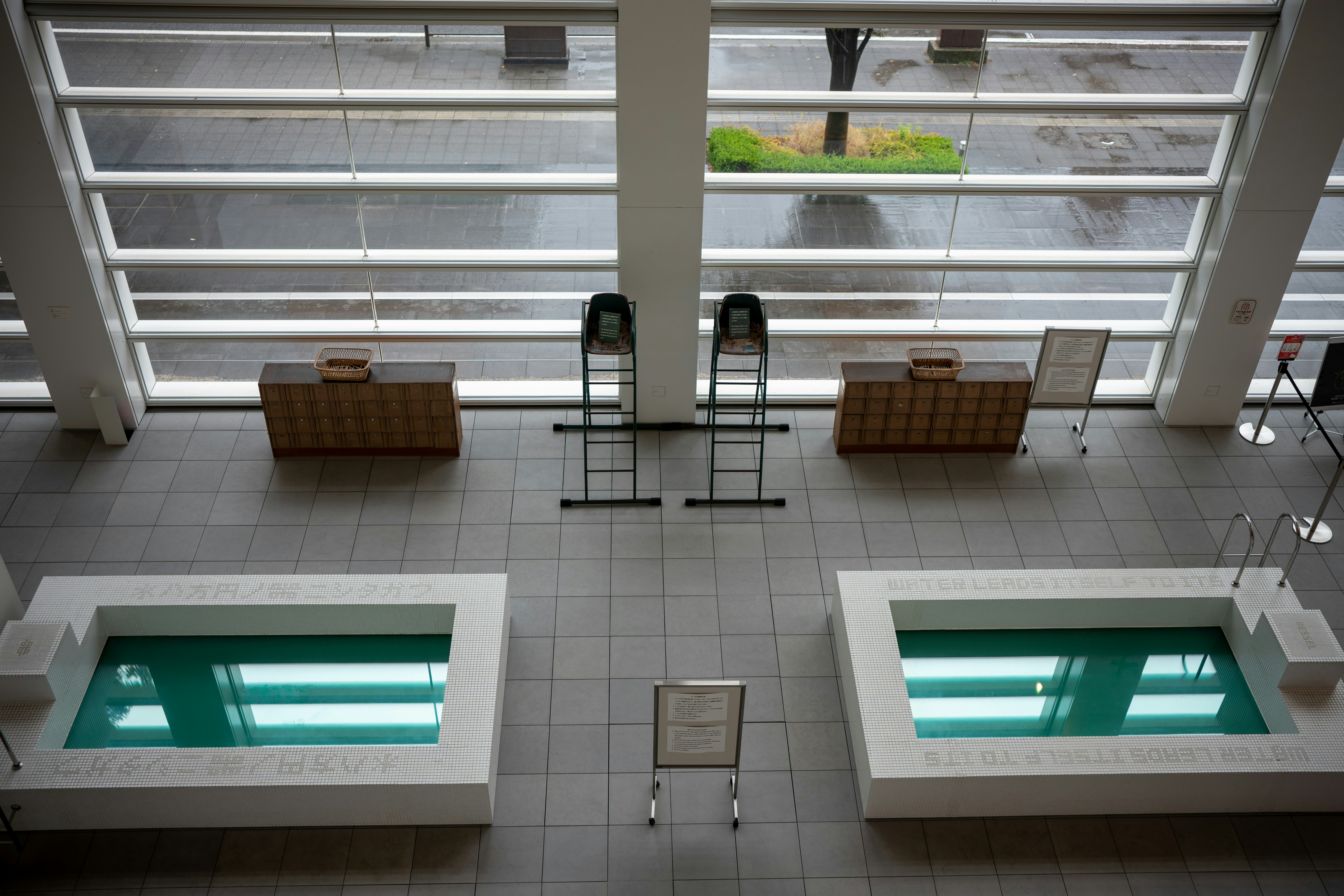 Symmetry in the Atrium: A Quiet Balcony Between Pools