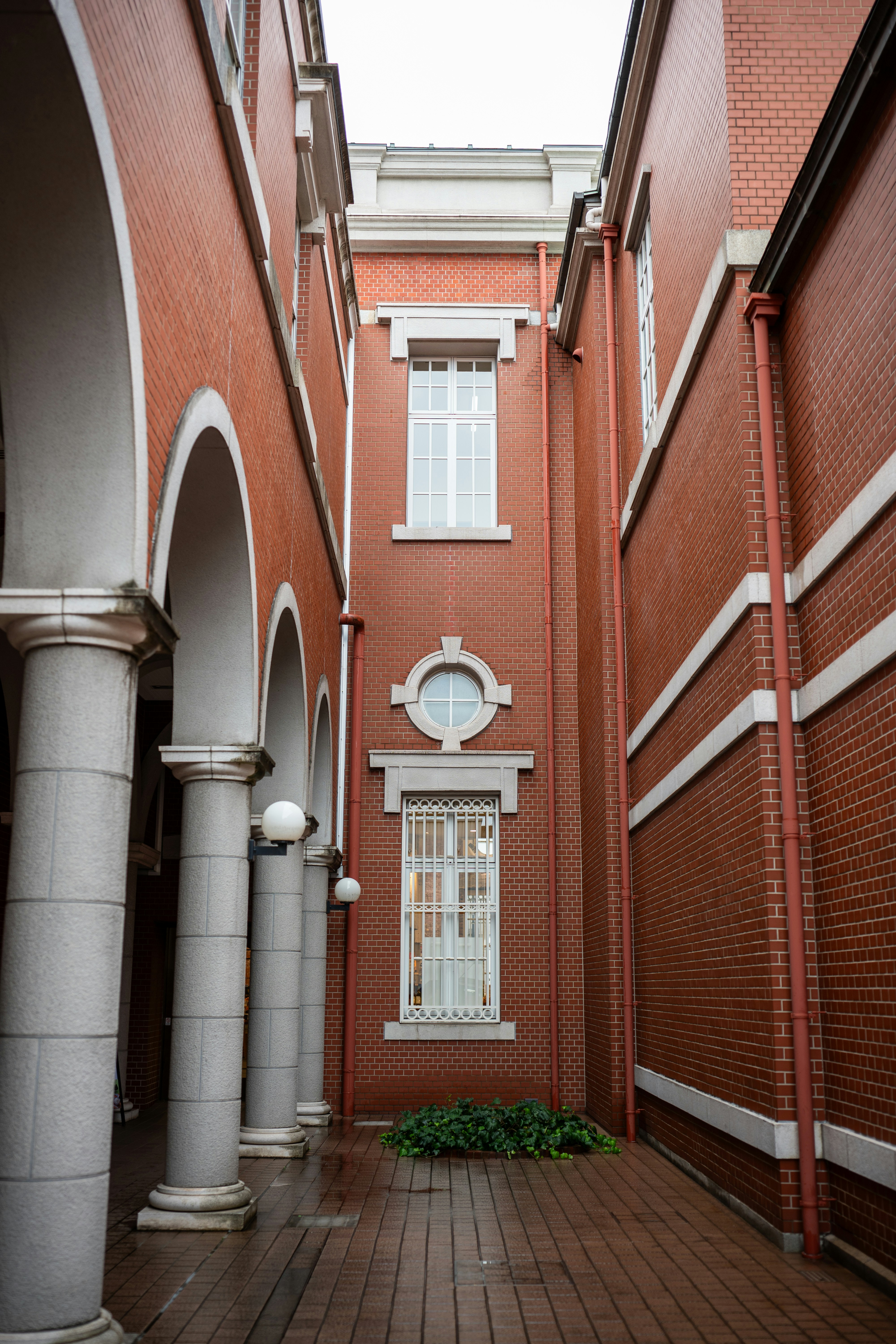 Brick Courtyard Vista: Red Facades Framing a Quiet Arch