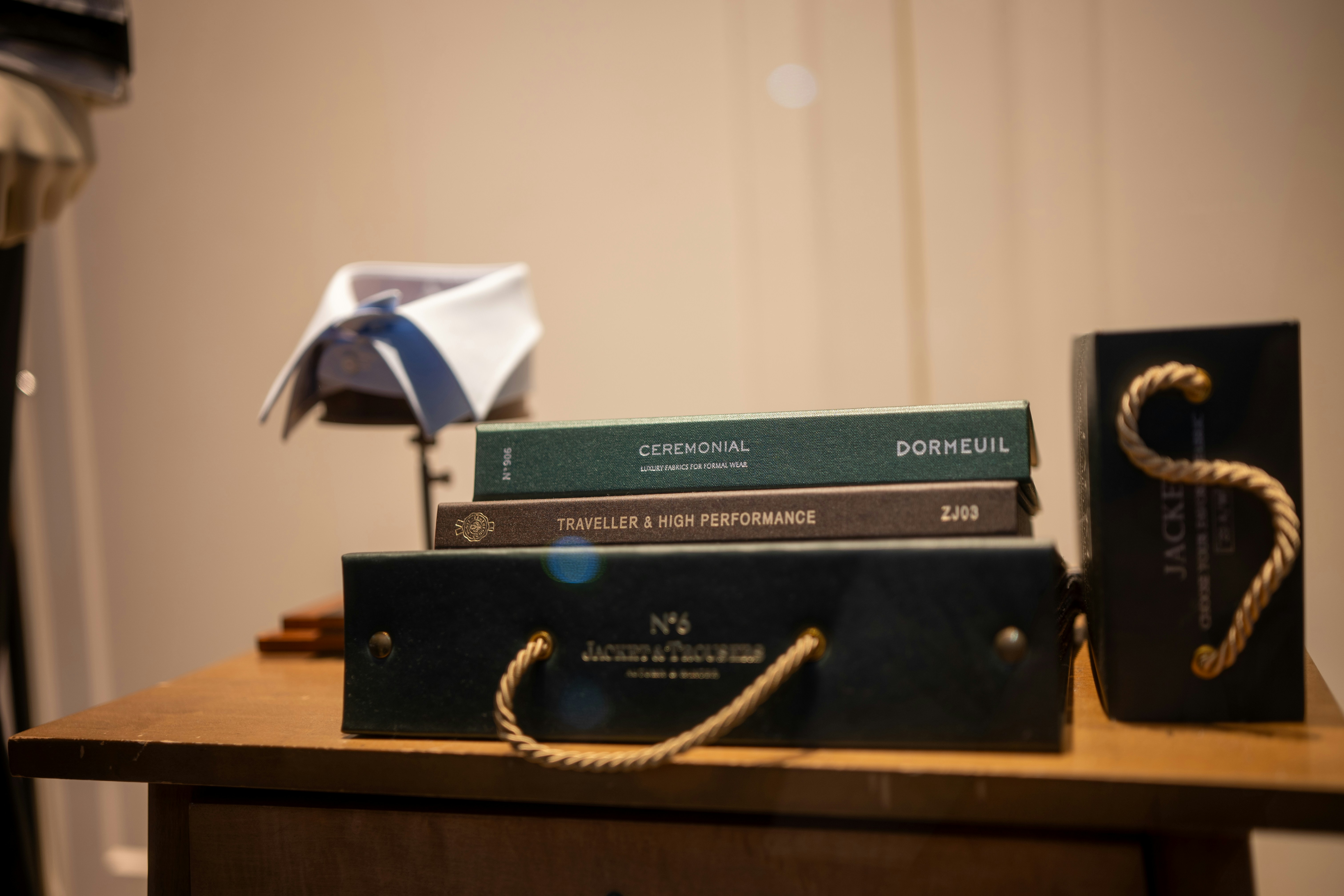 Stacked Objects on a Wooden Surface: A Quiet Still Life of Books and Bag