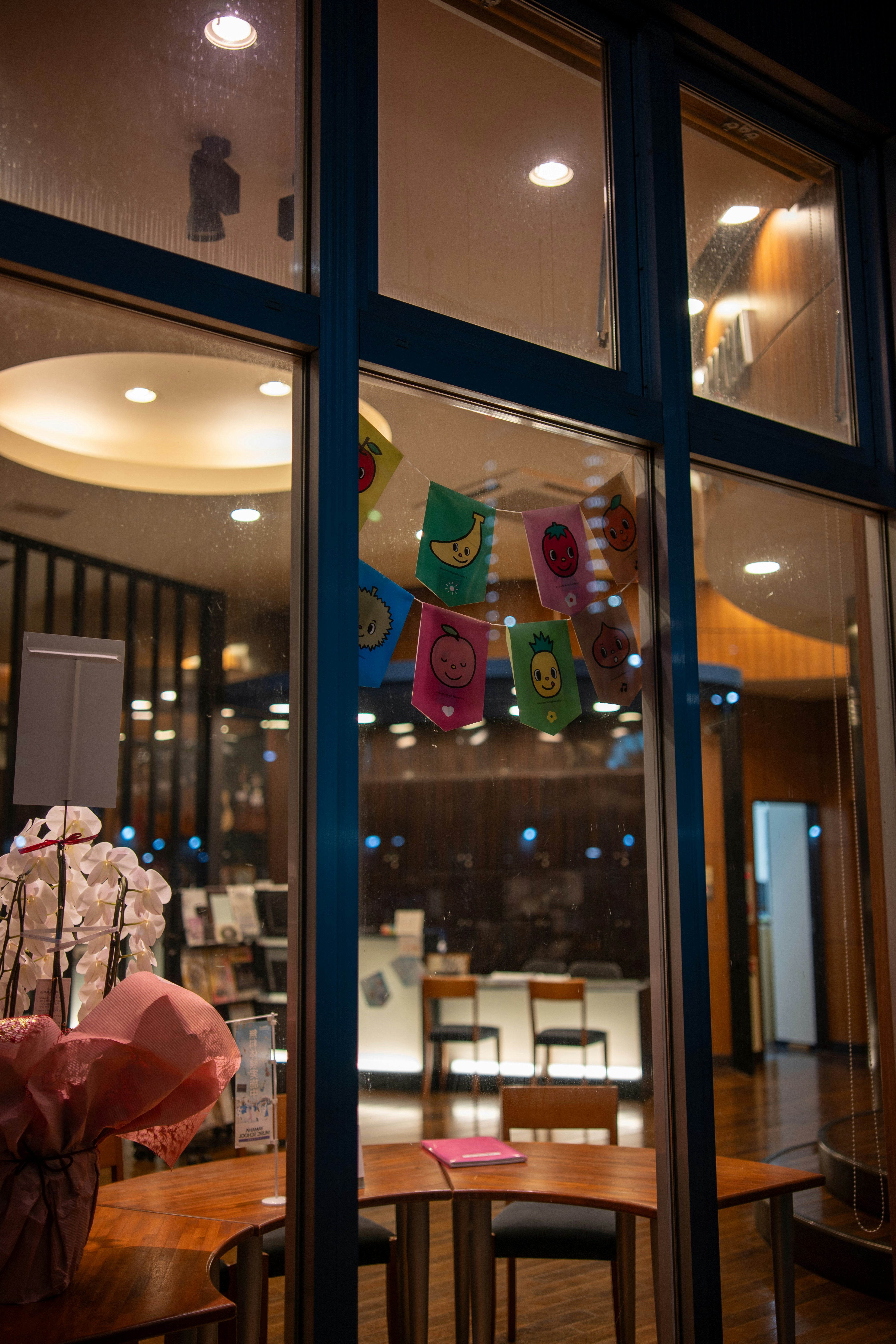 Glimmering Interior Through a Glass Ribbon of Colorful Flags
