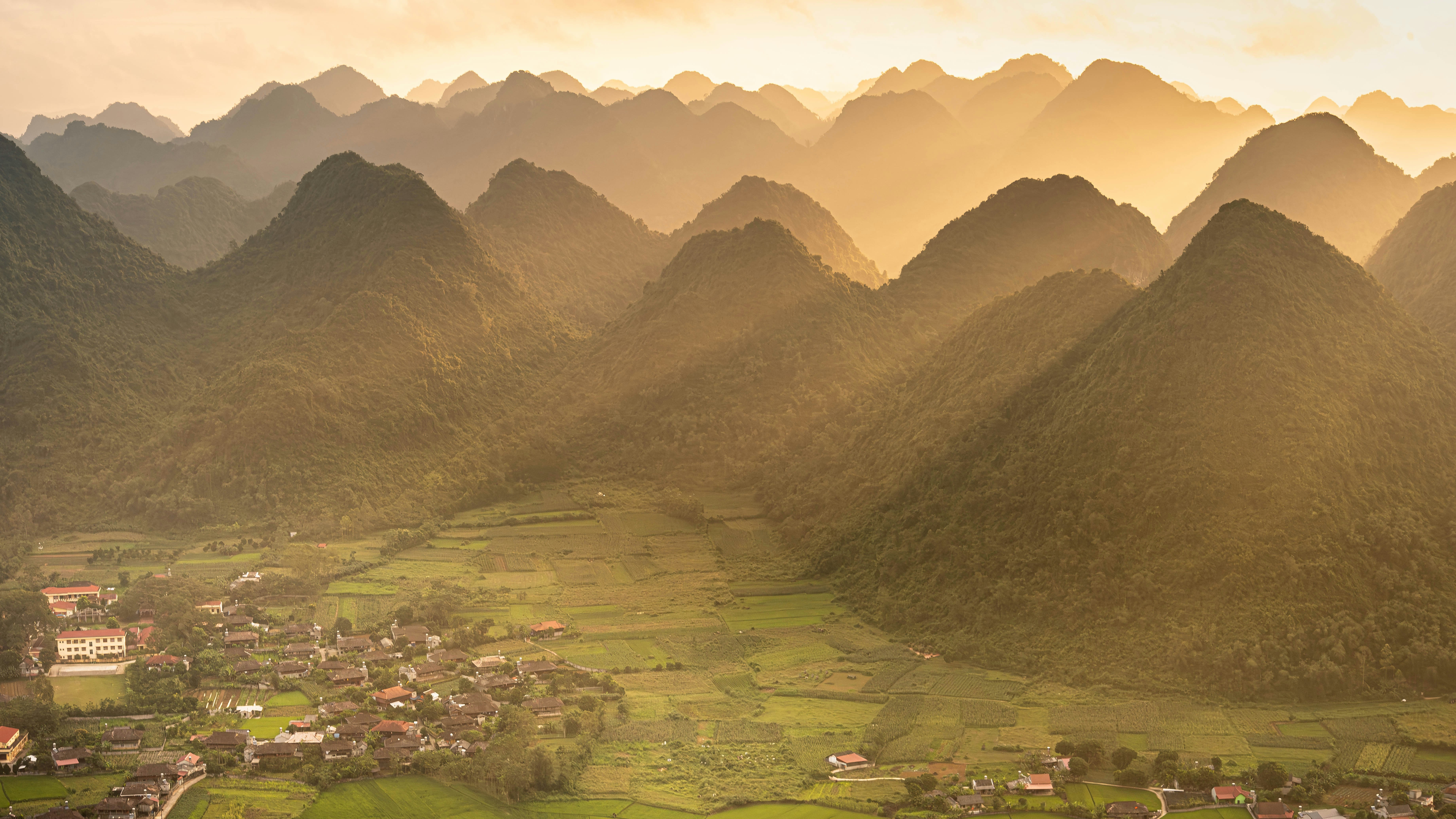Sunlit Karst Valleys: Morning Shimmer Over Terraced Fields