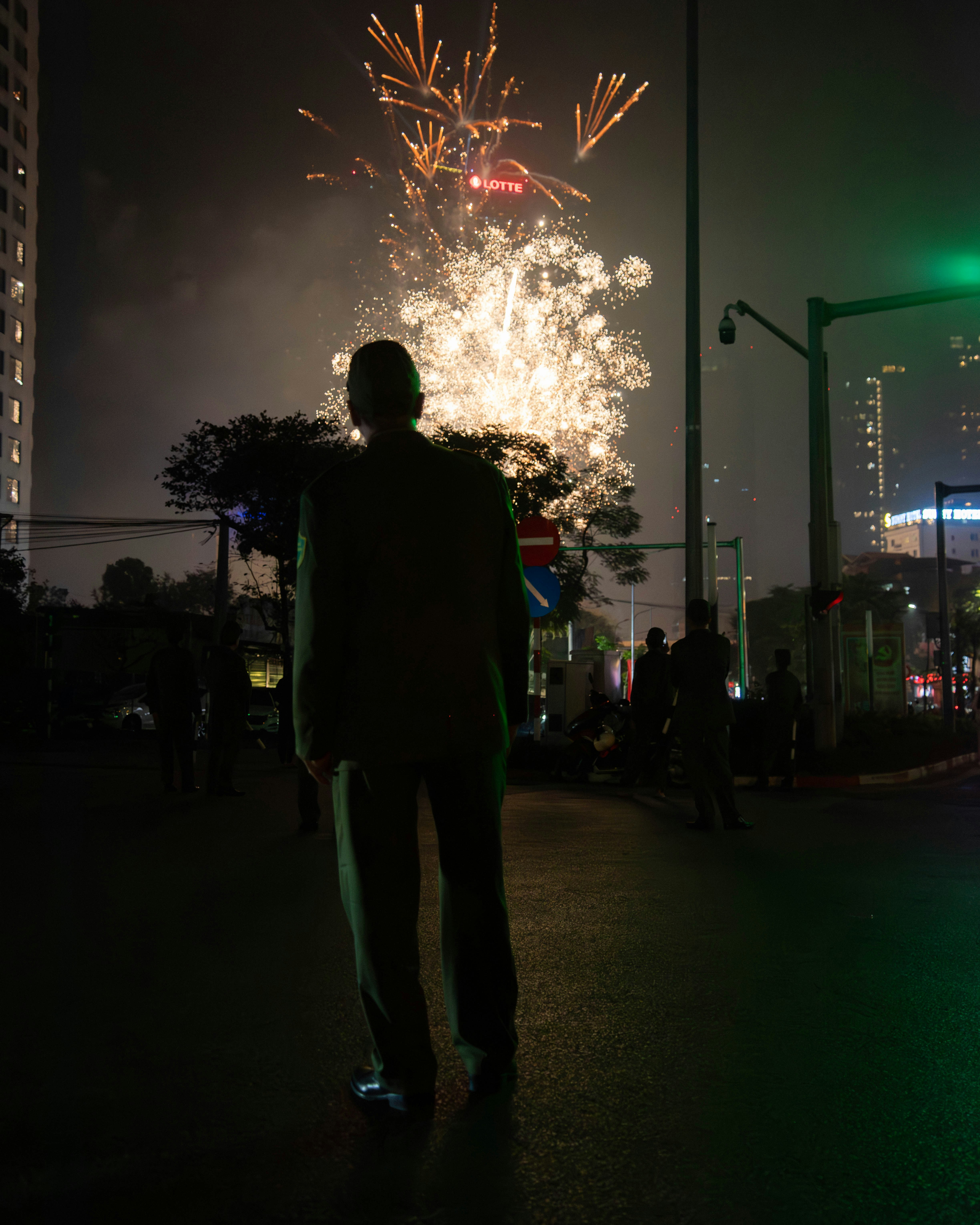 Silhouette of a Nightwalker Under Firework Skies