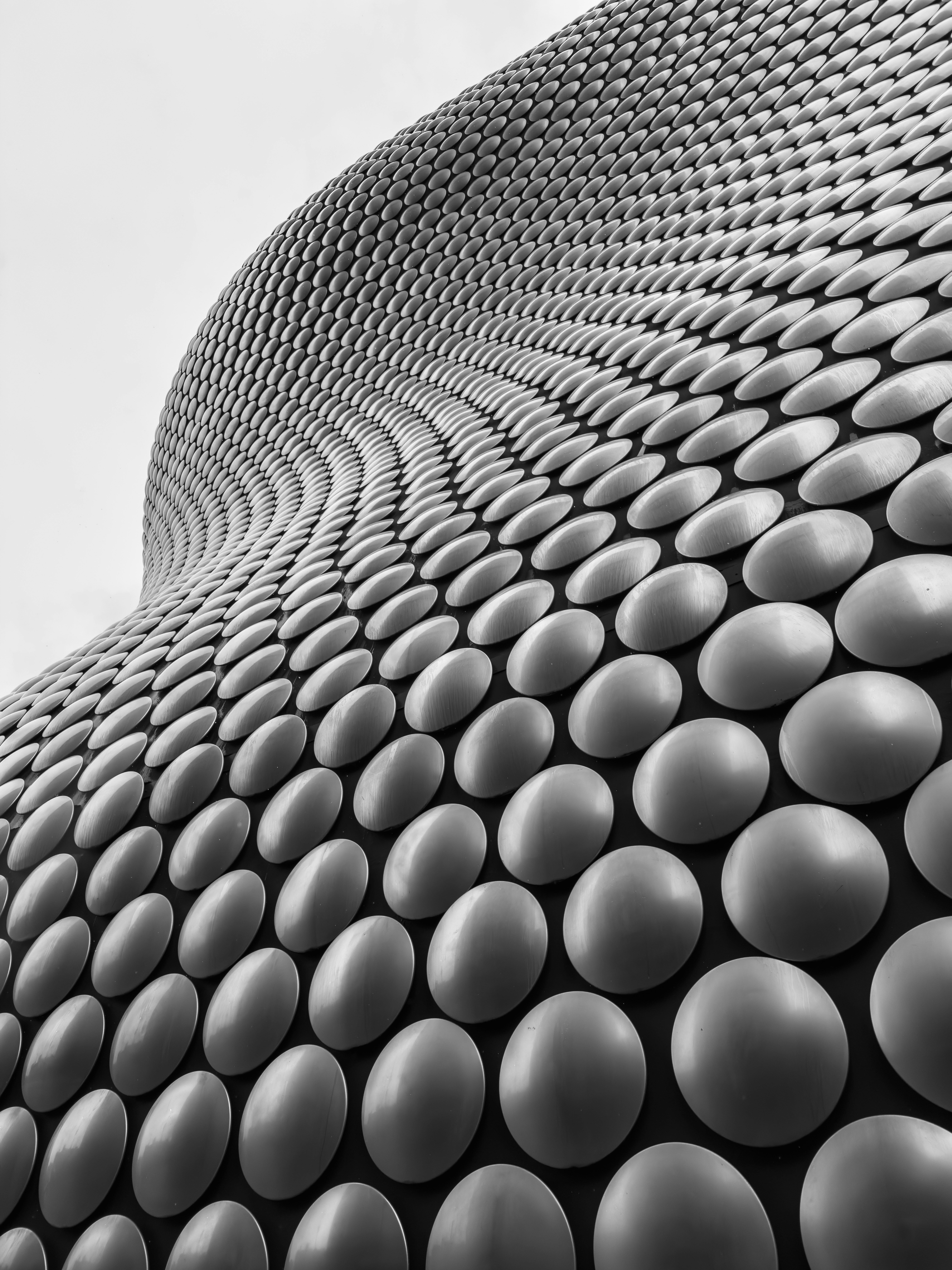 Converging Orbs: A Curved Facade of Repeating Dots