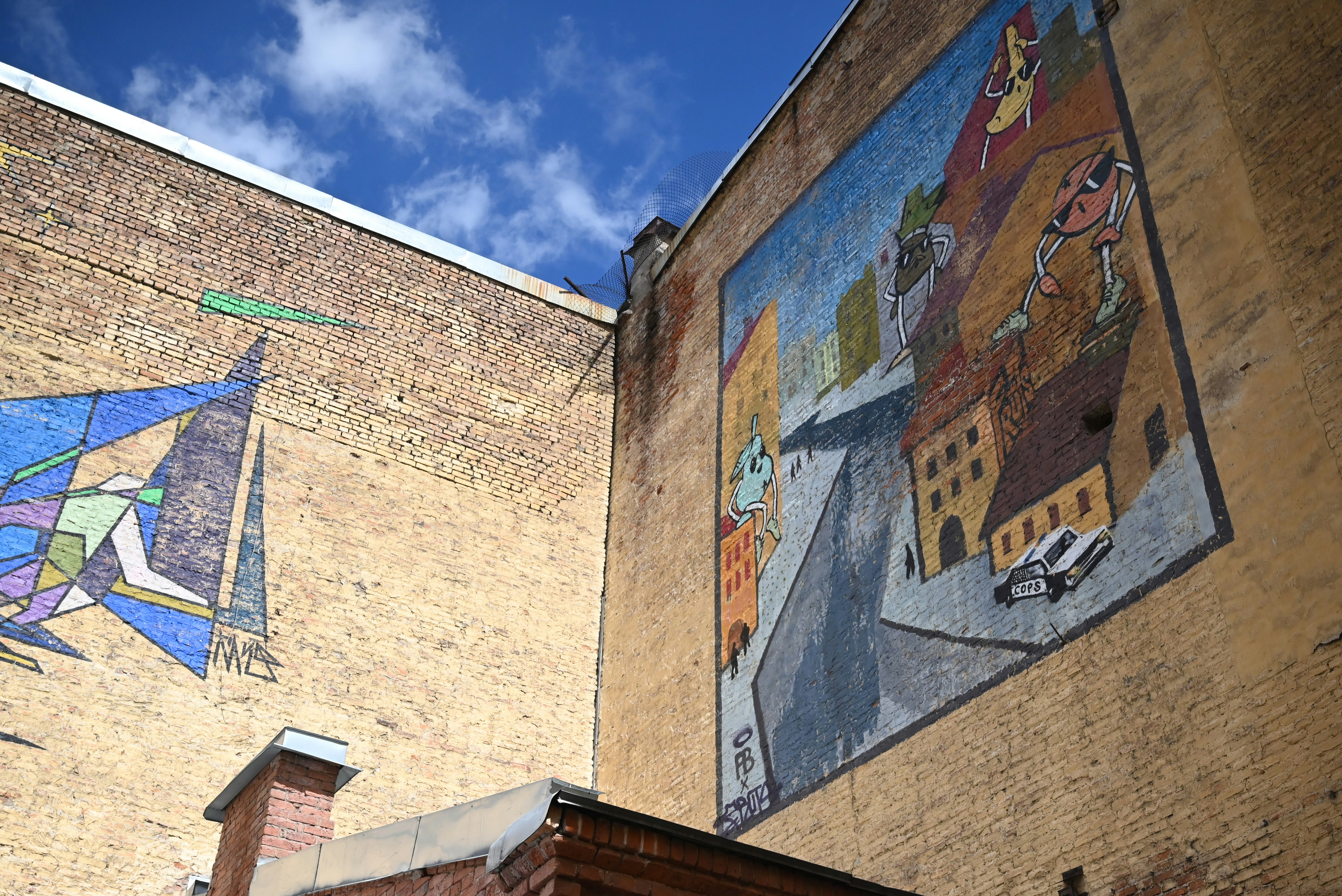 Murals on Brick Facades: Colorful Stories across a Corner