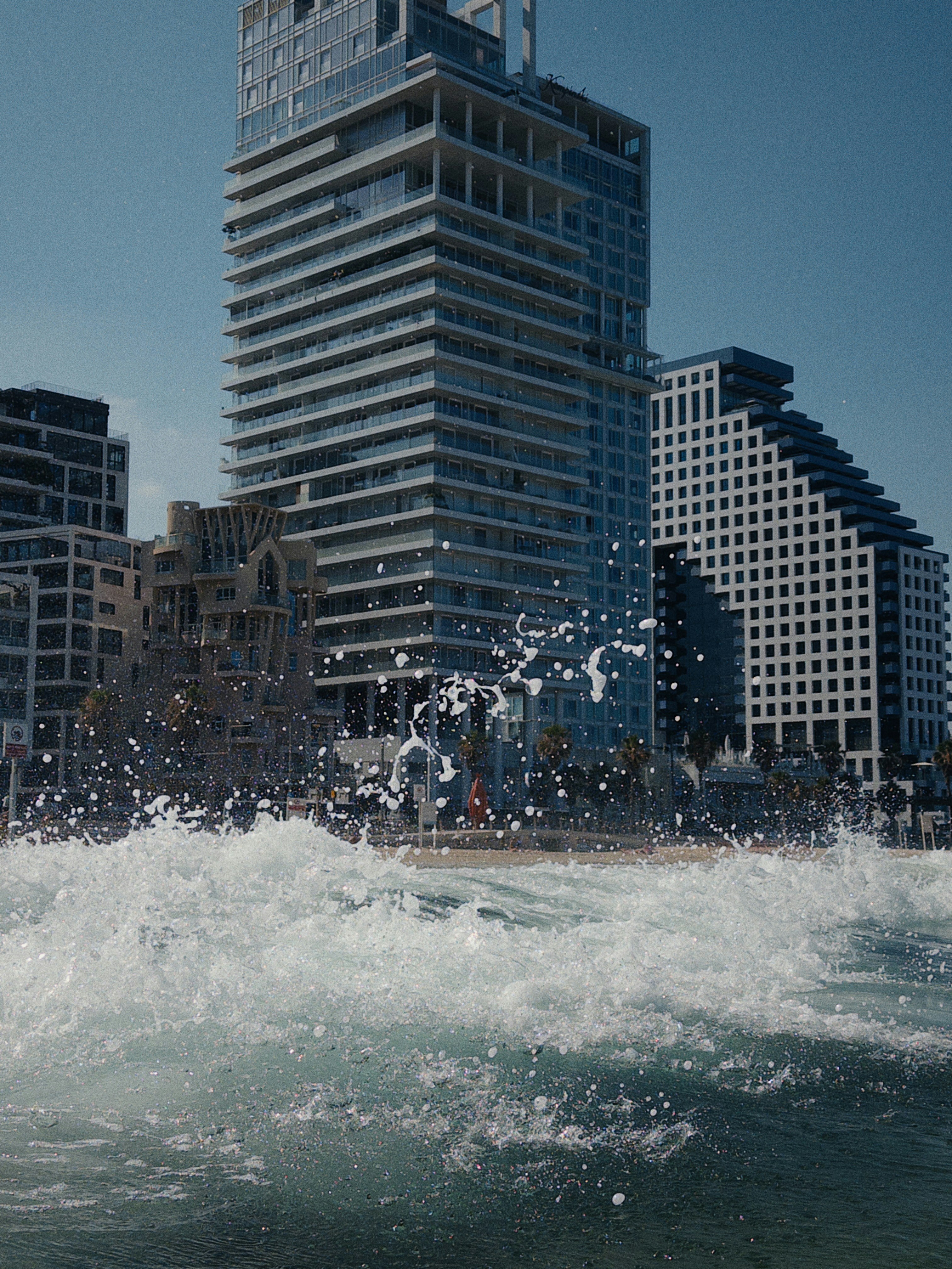 Urban Coastline: Waves Meet Skyscrapers at Dusk