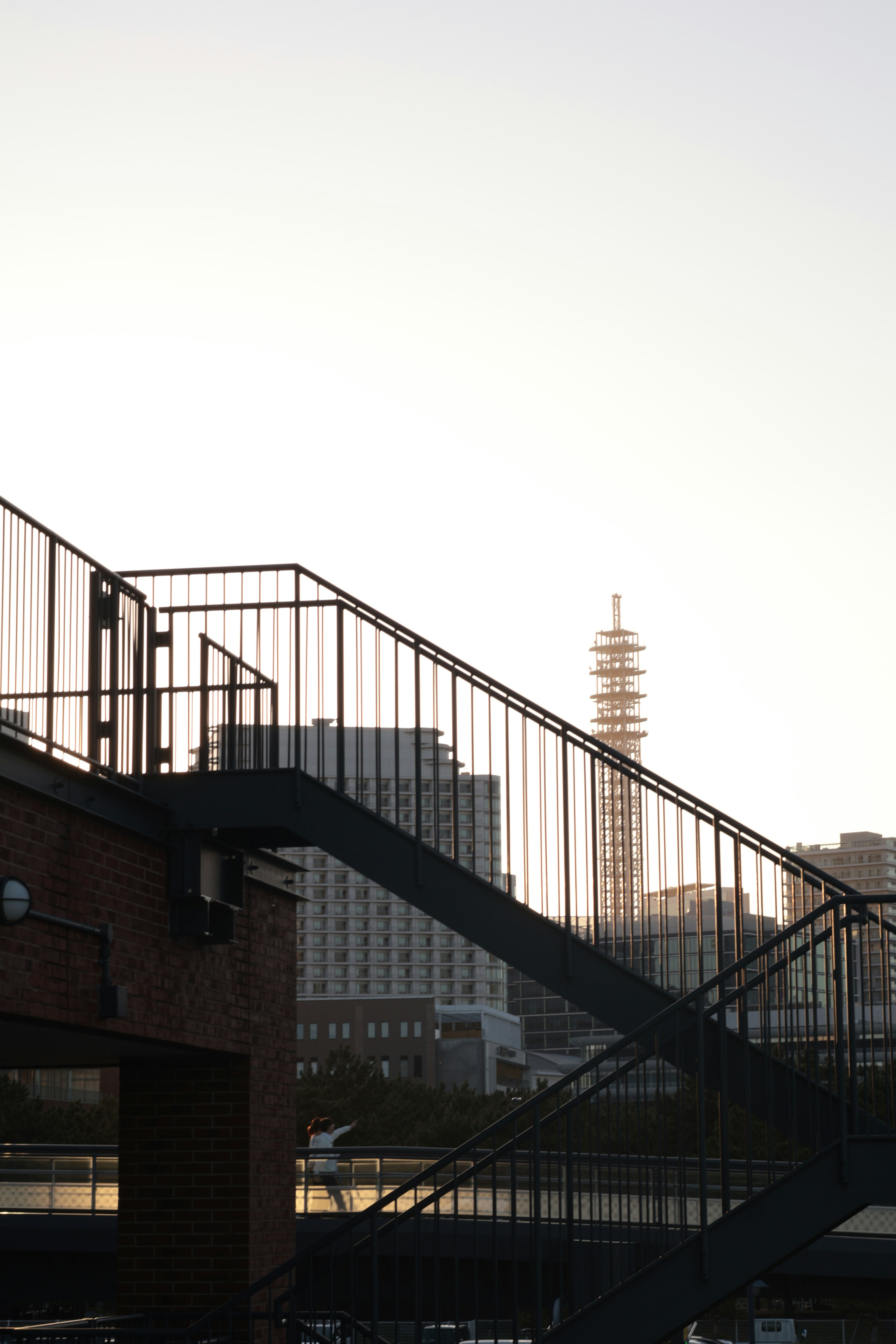 Rooftop Staircase Silhouette Against a Quiet City Dawn