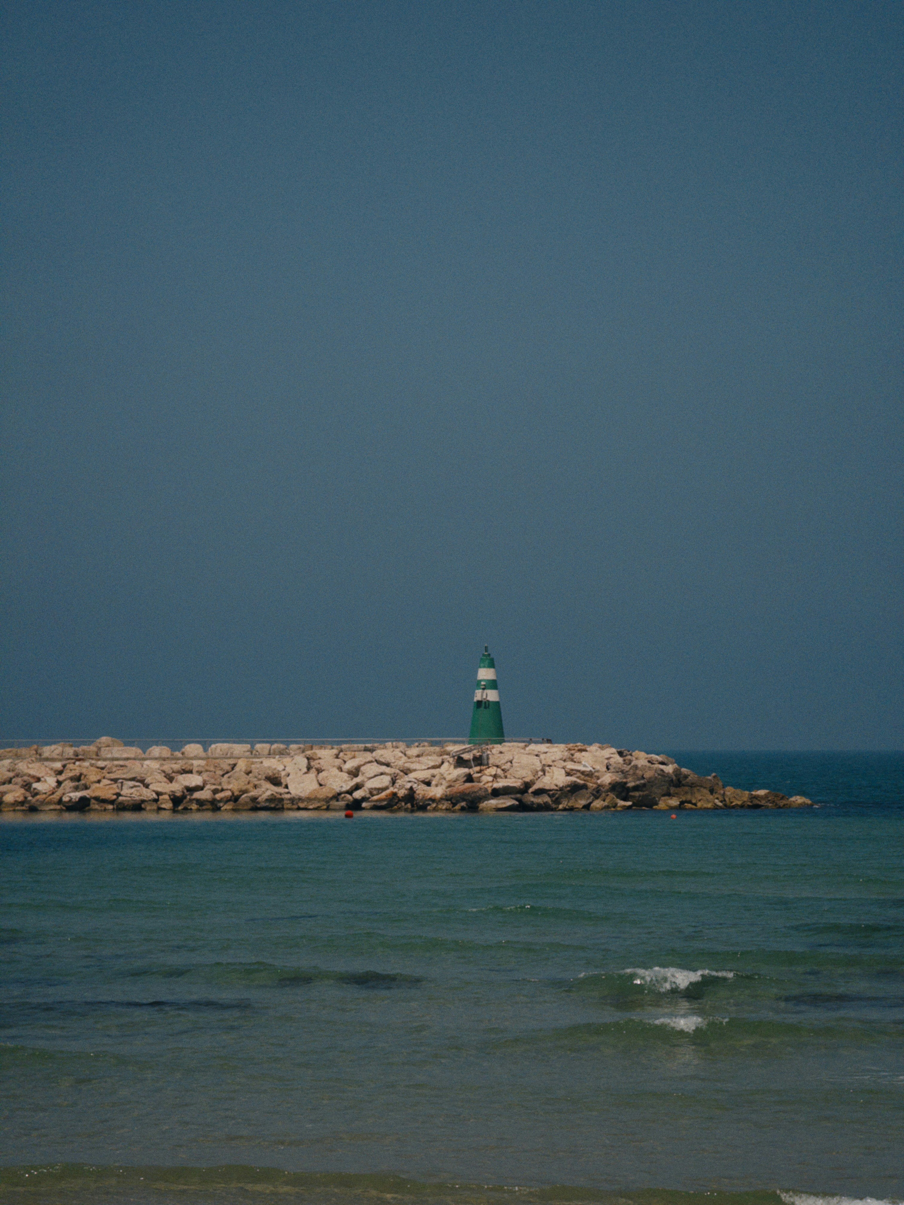 Lighthouse Sentinel on a Quiet Breakwater
