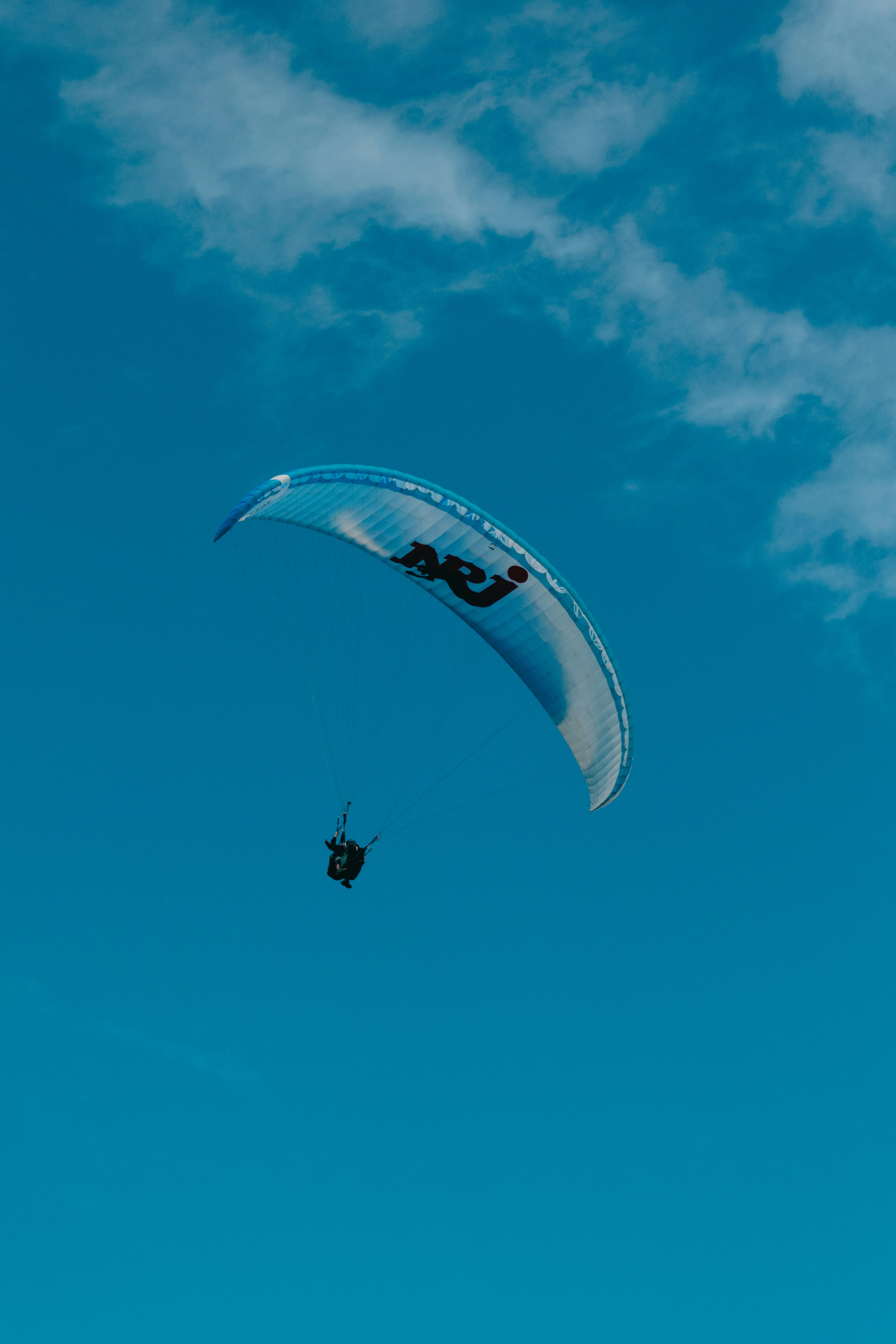 Aloft in Blue: Paraglider Against a Quiet Sky