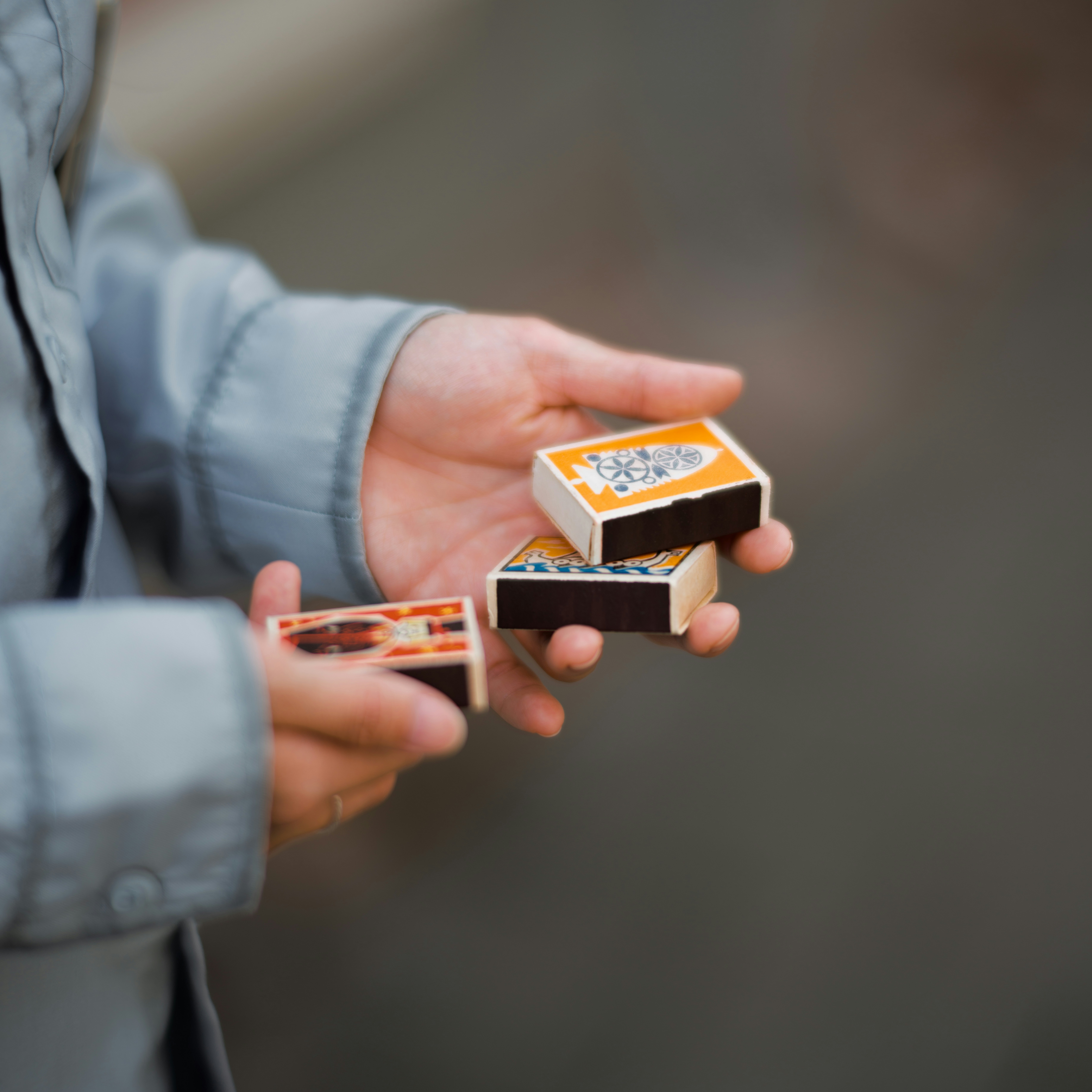 Hands in Focus: Tiny Matchbox Marvels in Soft Light
