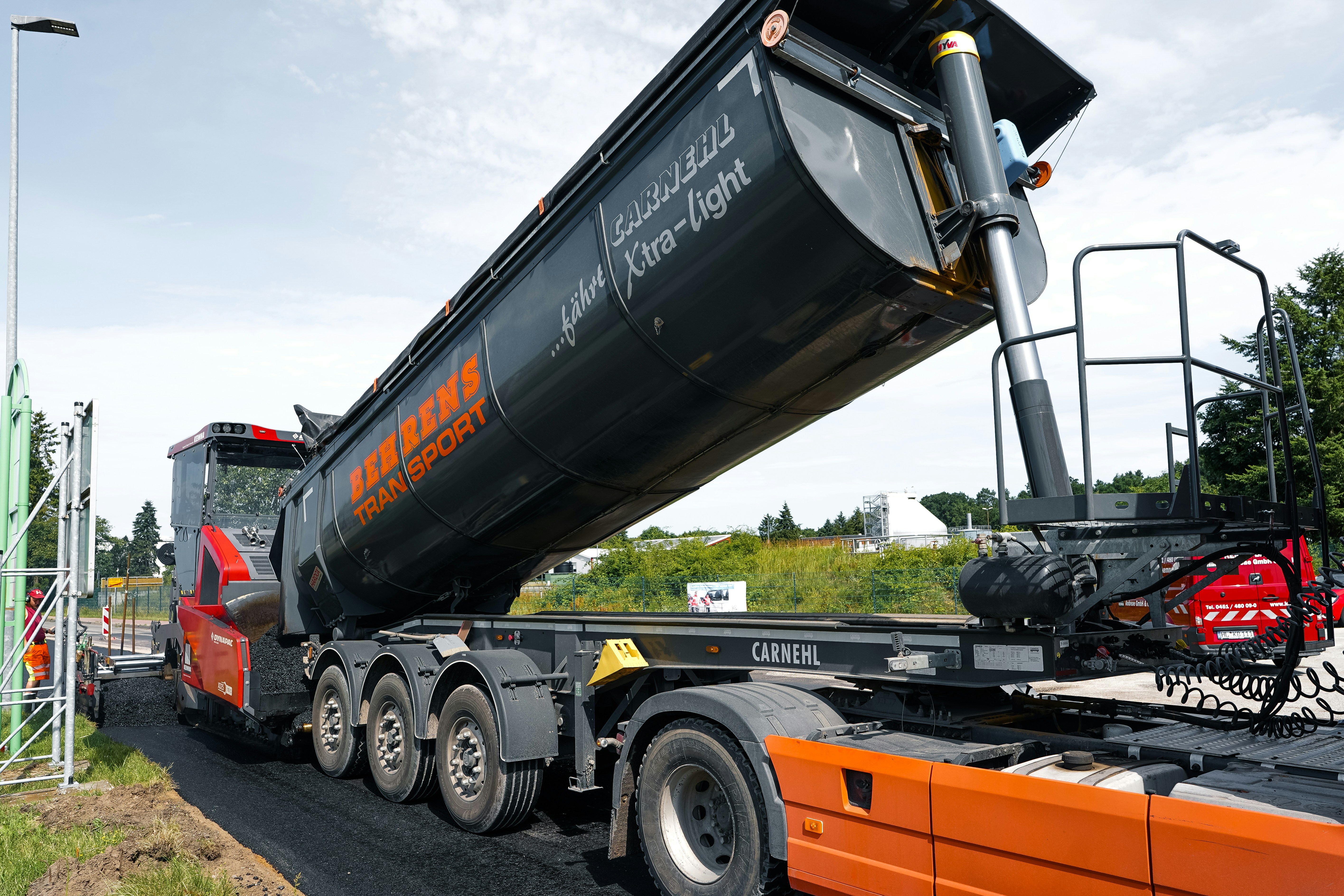Heavy Lifter: A Construction Dump Truck Tips the Load at a Clearing Site