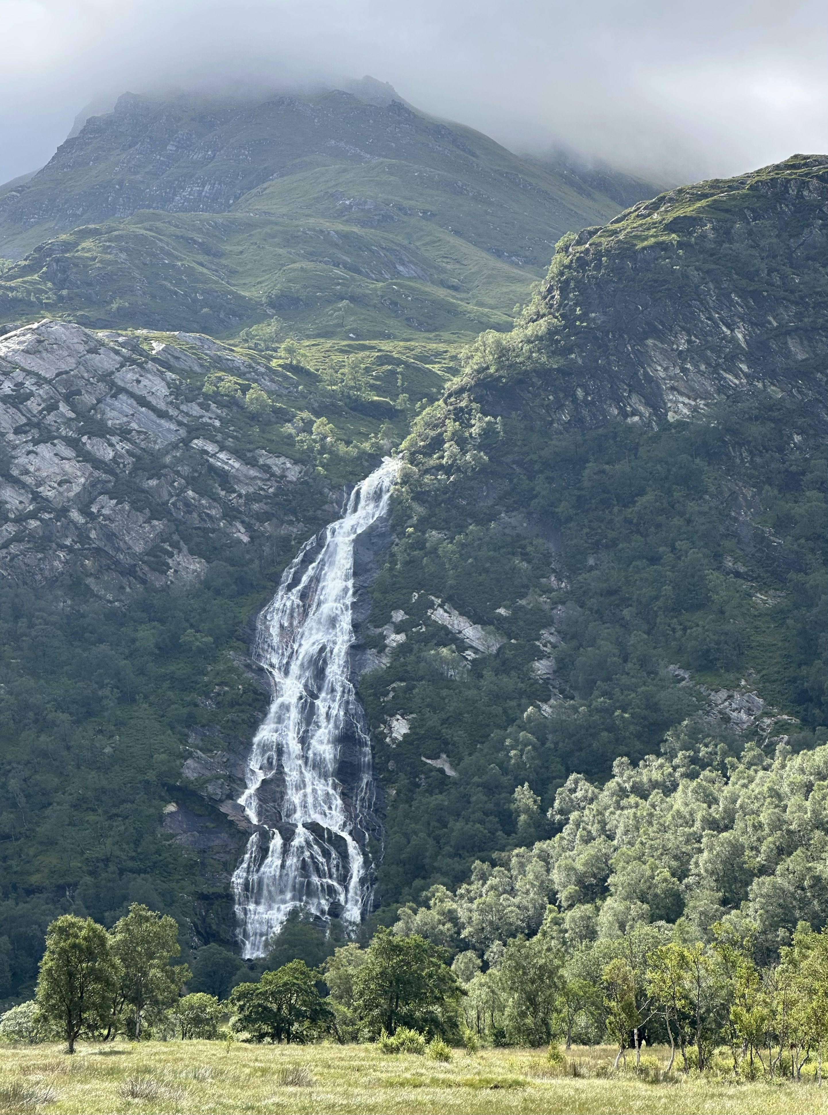 Mist-Lifted Cascade Between Roaring Peaks