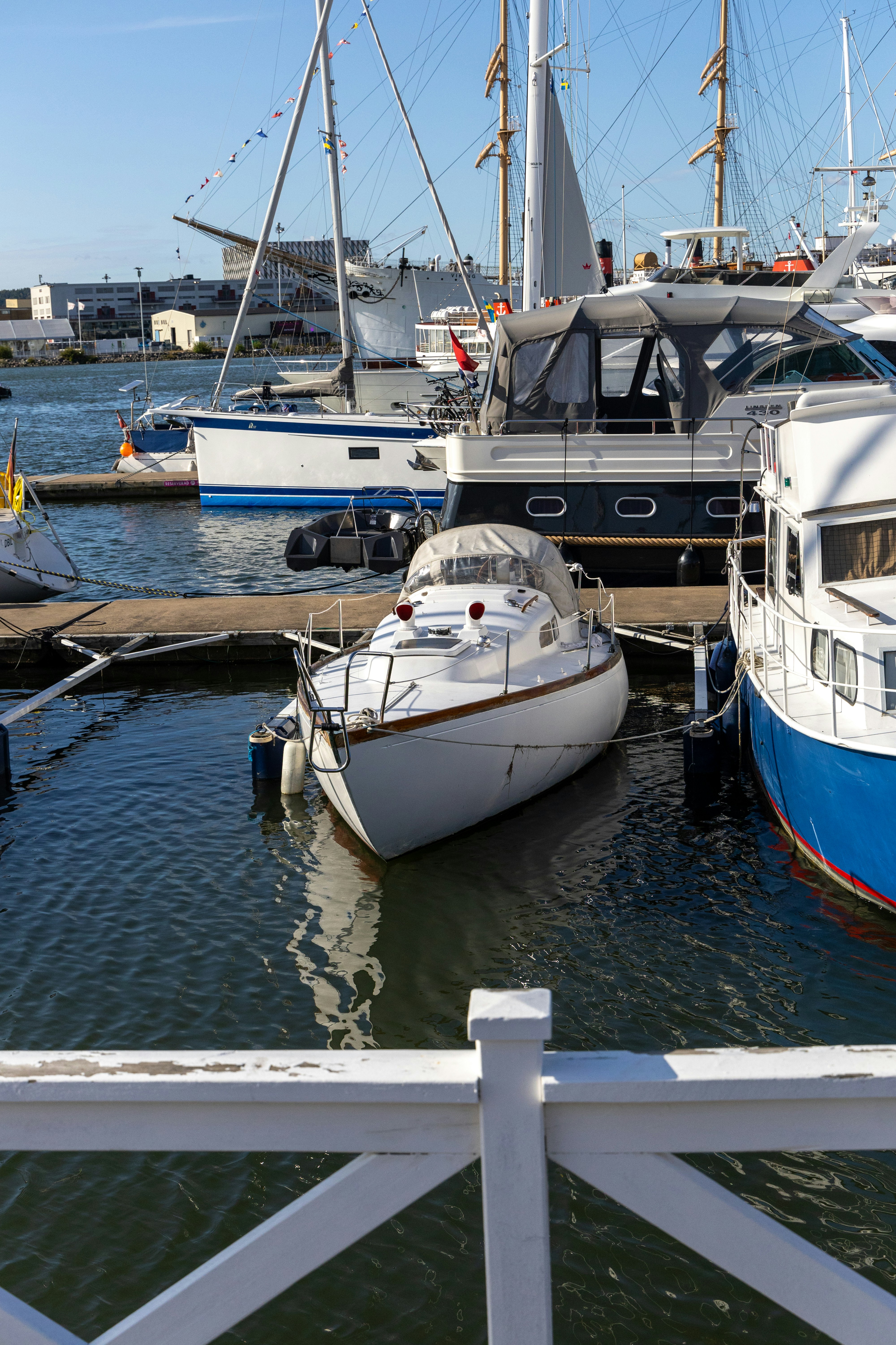 Harbor Lines: A Quiet Fleet Nestled by the White Fence
