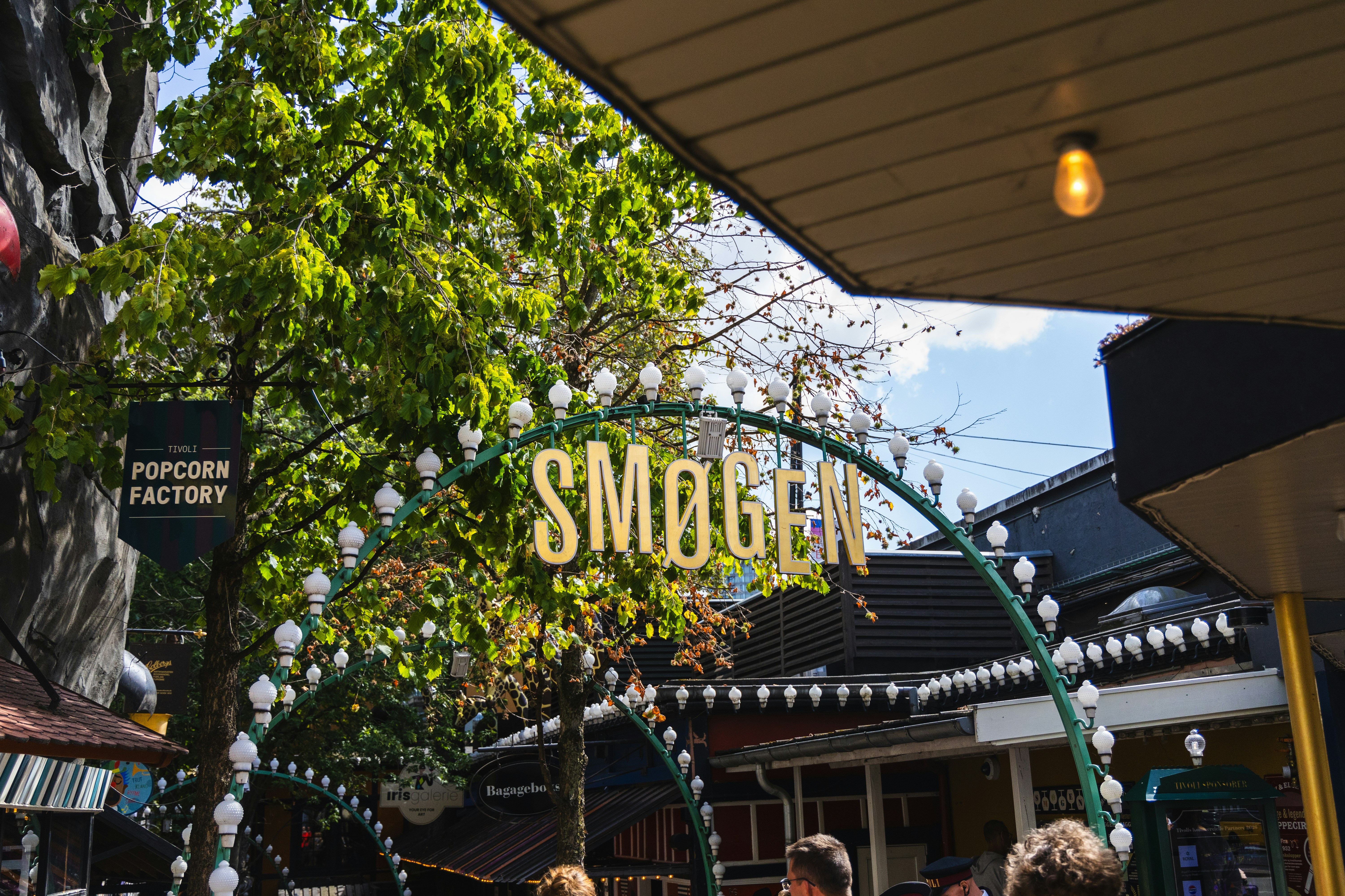 Smögen Fair Gate: A Sunlit Arc and Crowd Beneath festive bulbs