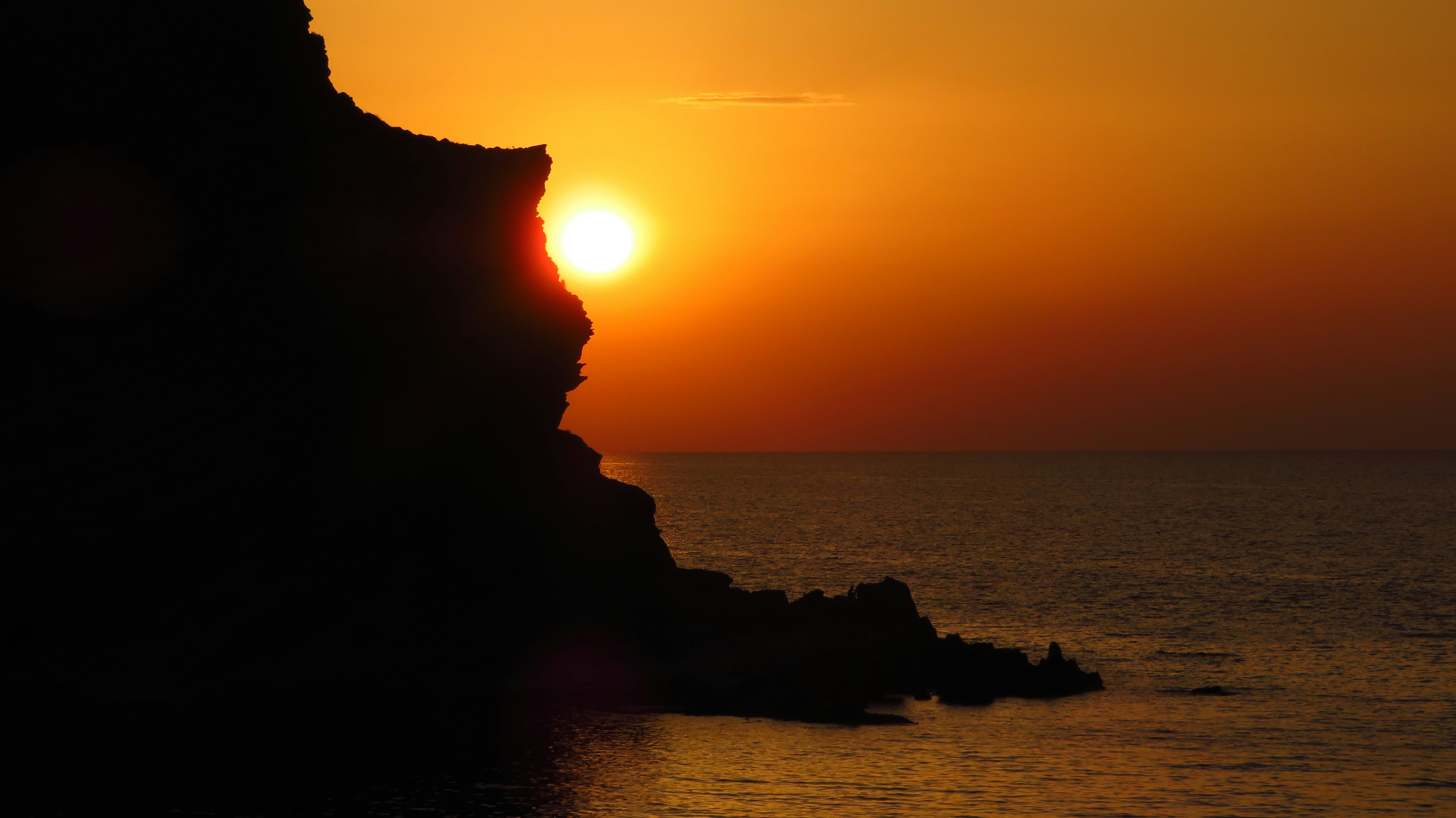 Sunlit Cliff Embraces a Quiet Horizon