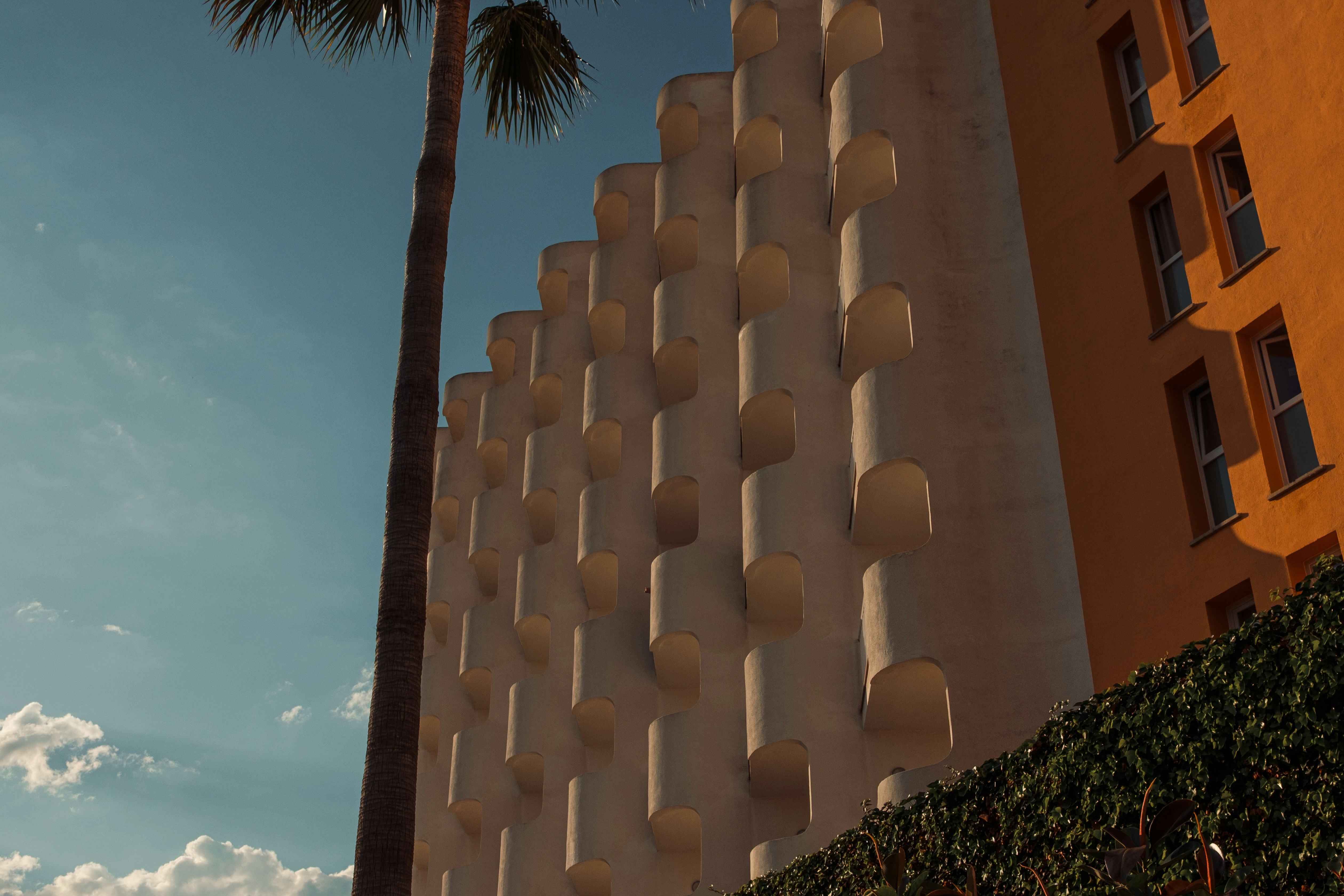 Vertical Facade Echo: Concrete Arches Against a Sunny Sky