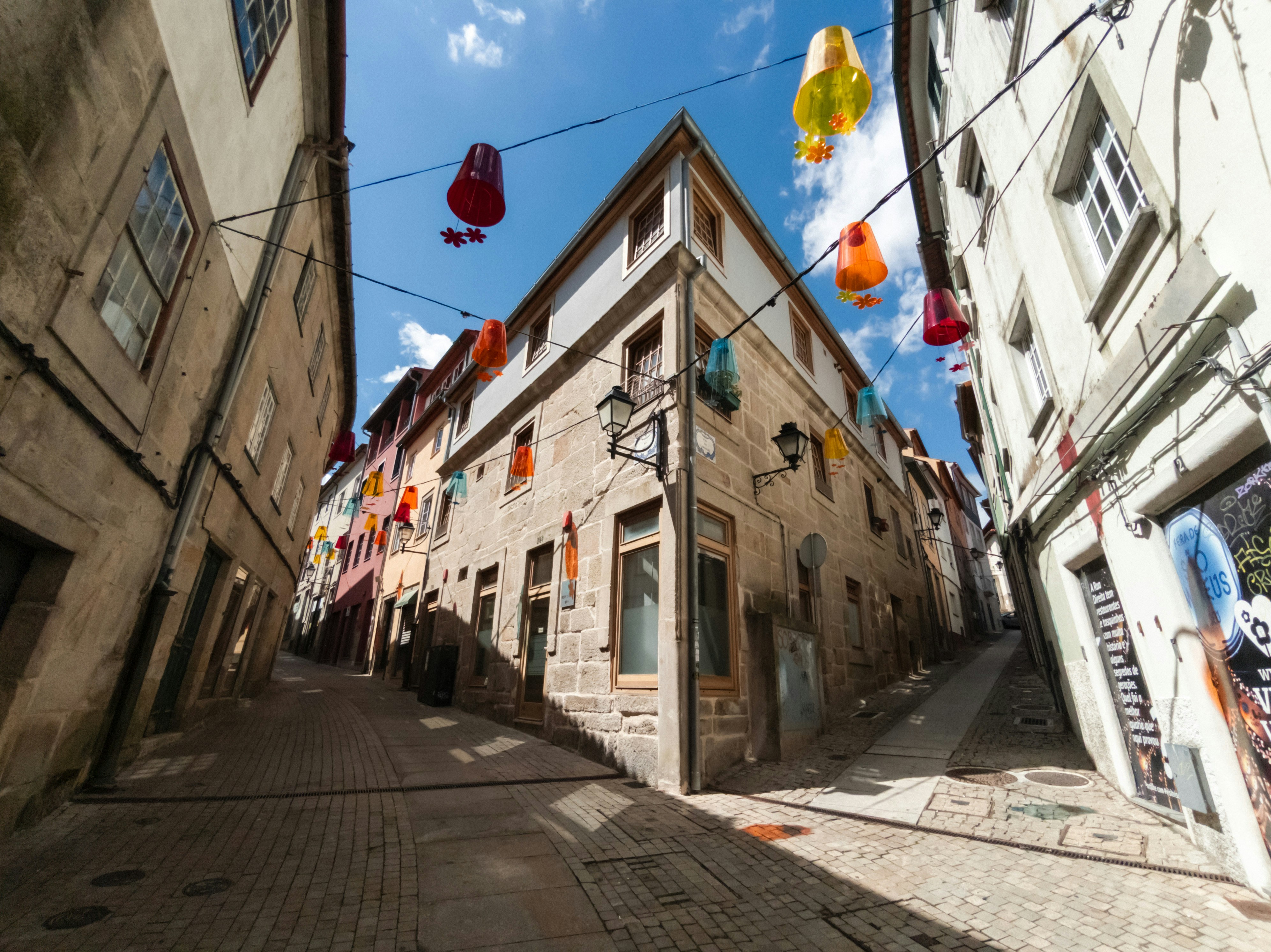 Colorful street lanterns guiding the bend through sunlit stone alleys