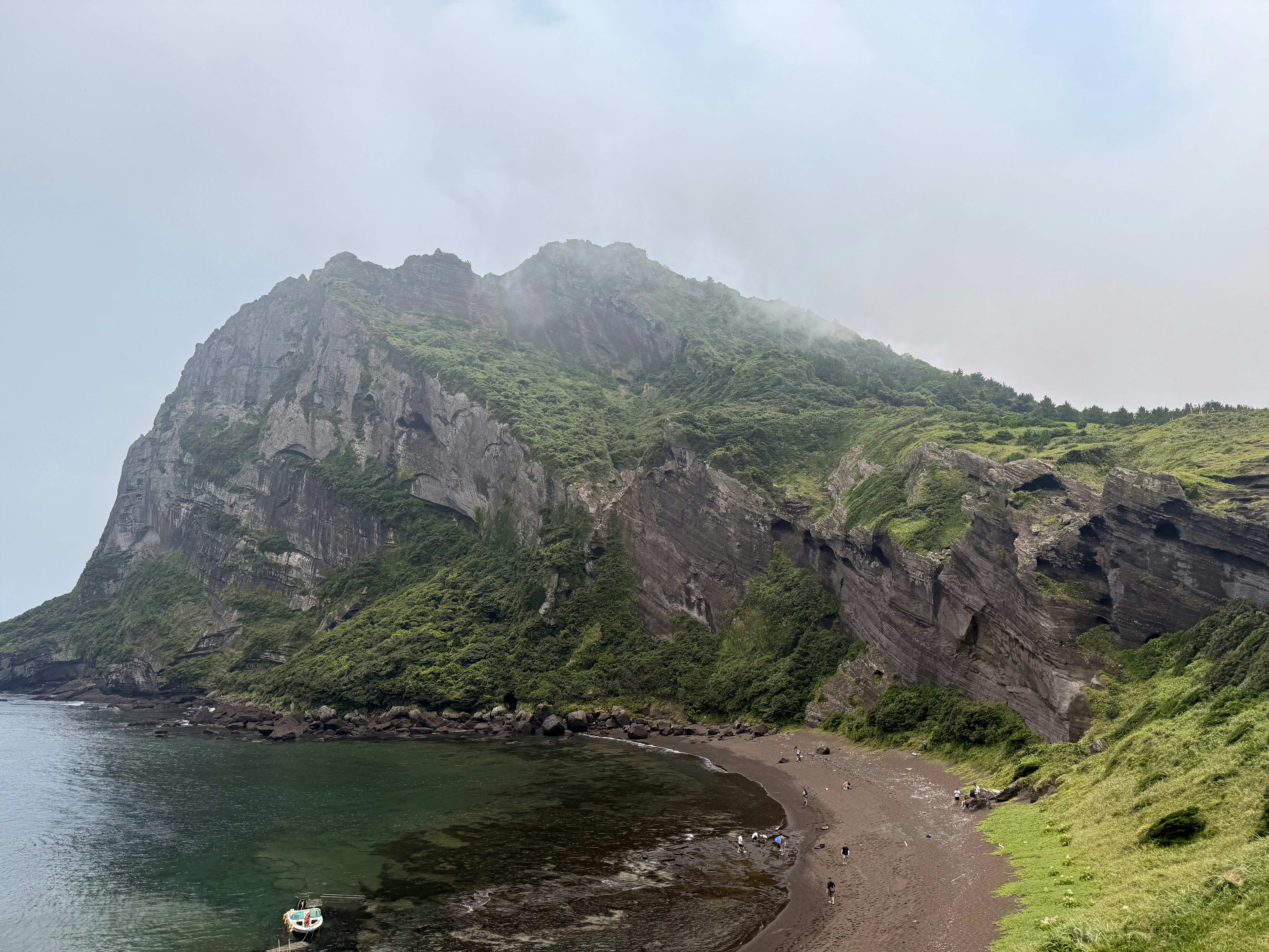 Coastal Cliffside Bend: Green Rugged Ridge Meeting the Quiet Shore