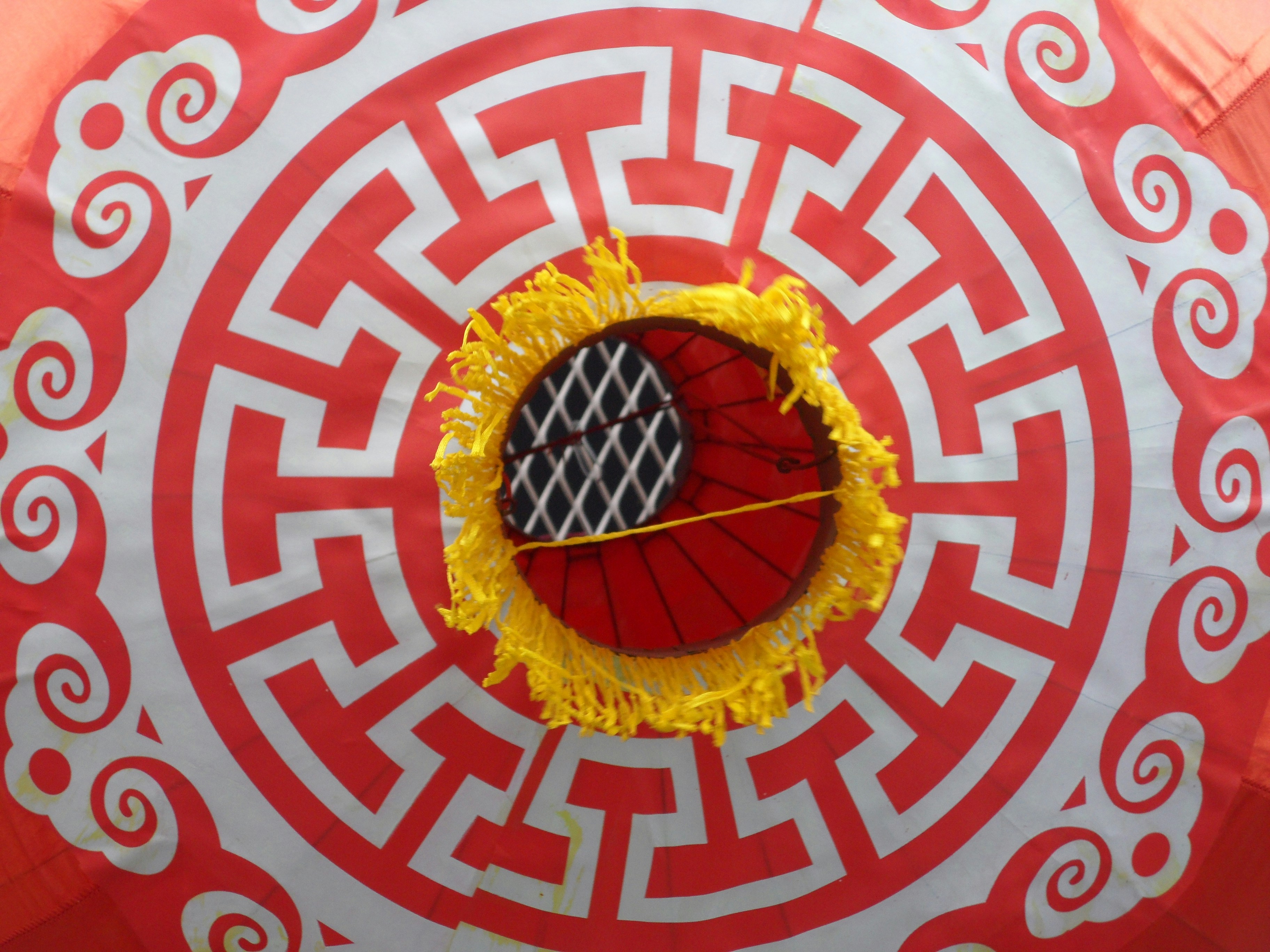 Red Lantern Veil: Circular Motif Framed by Intricate White Pattern