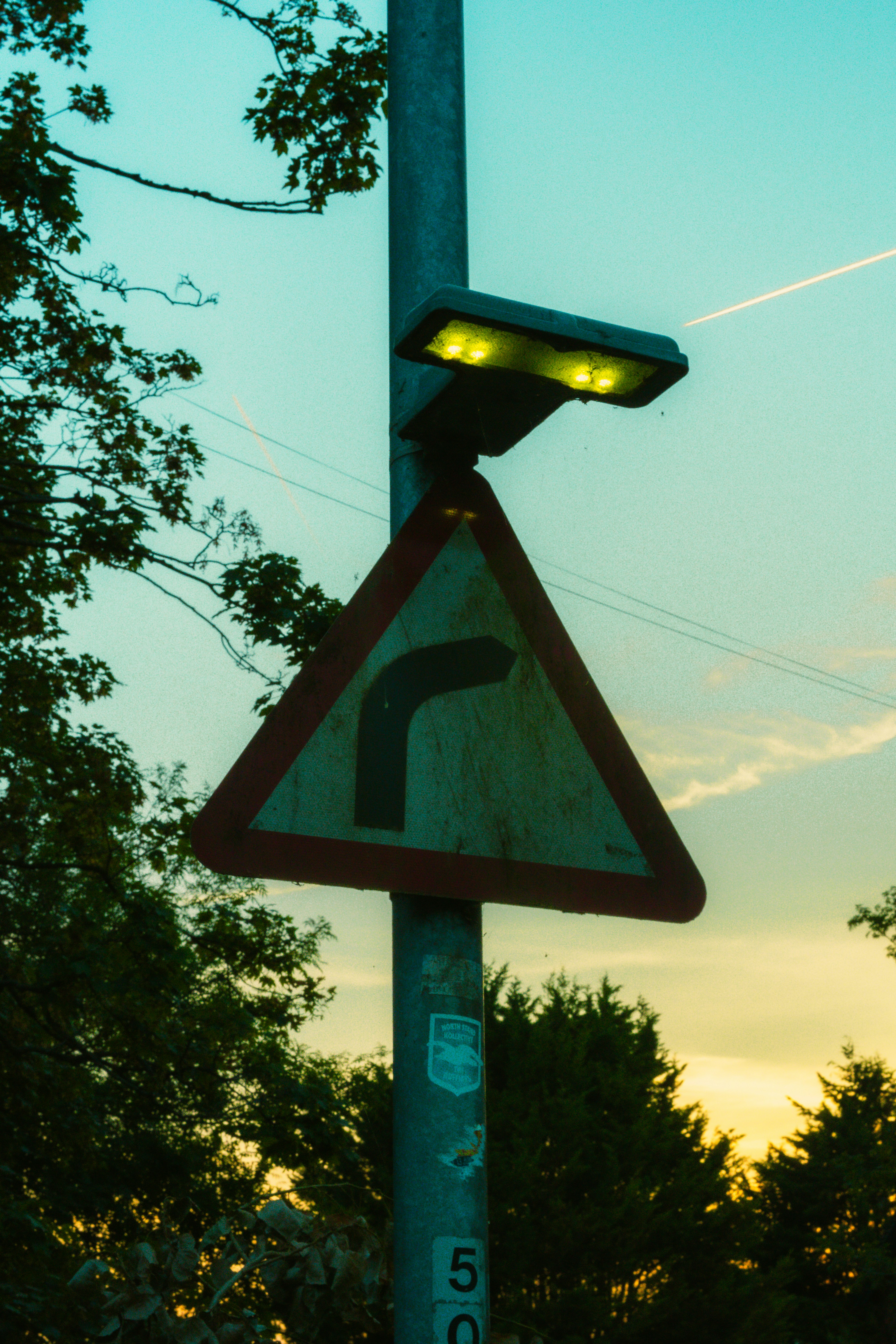 Copper Evening: A Leaning Triangle Under a Streetlamp