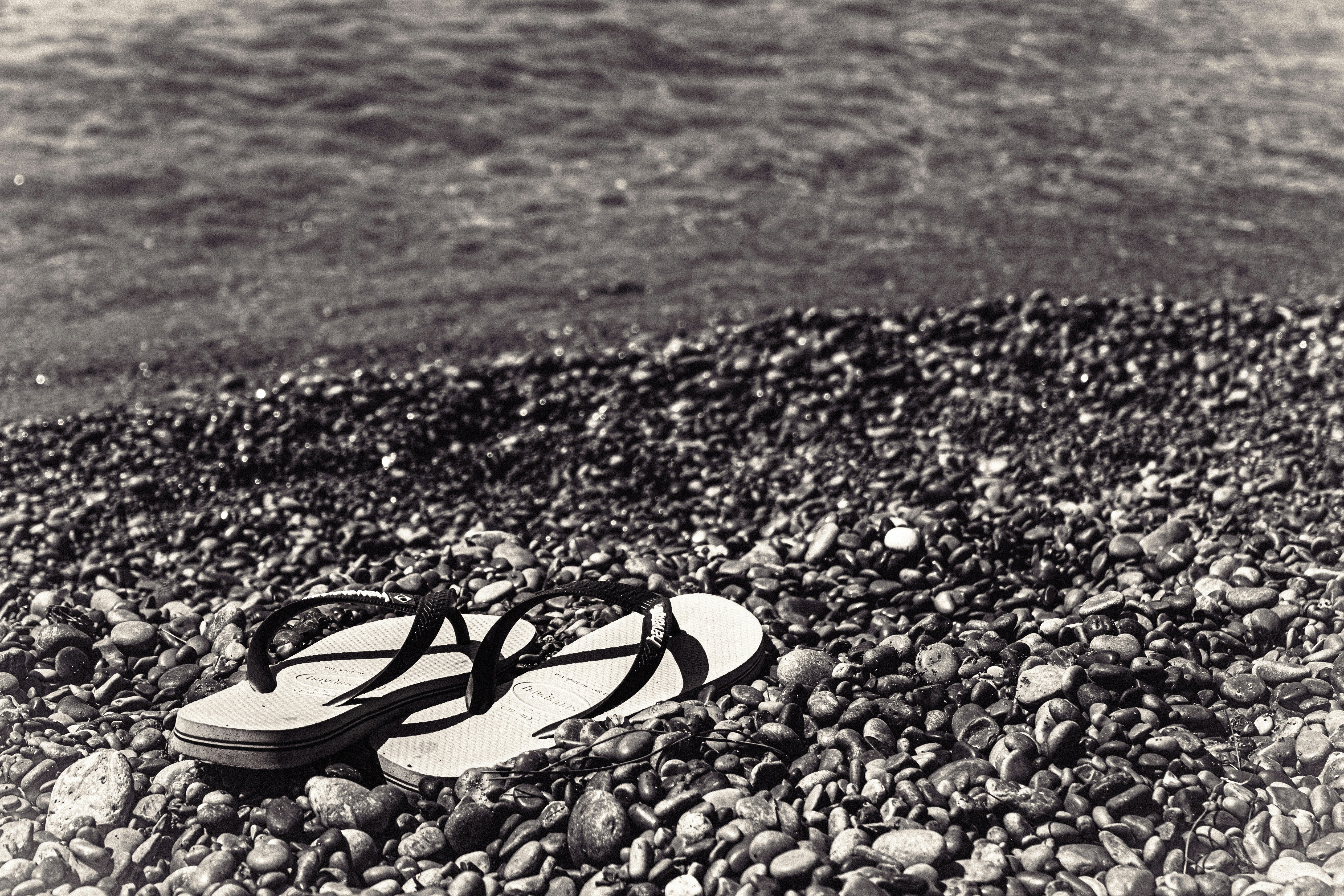 Pebble Harbor: Flip-Flops Resting by the Shore