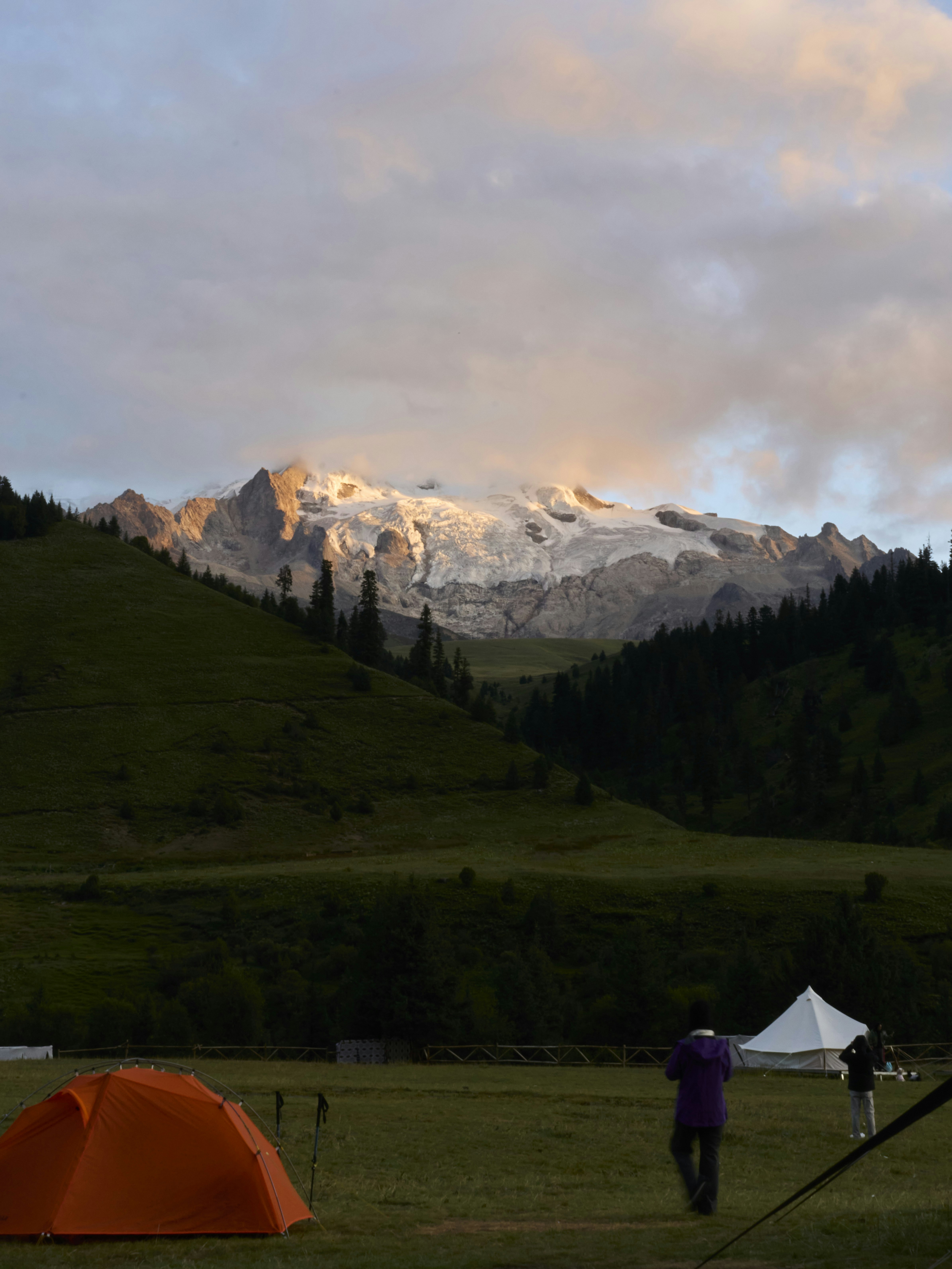 Sunlit Peaks Over a Measured Alpine Camp