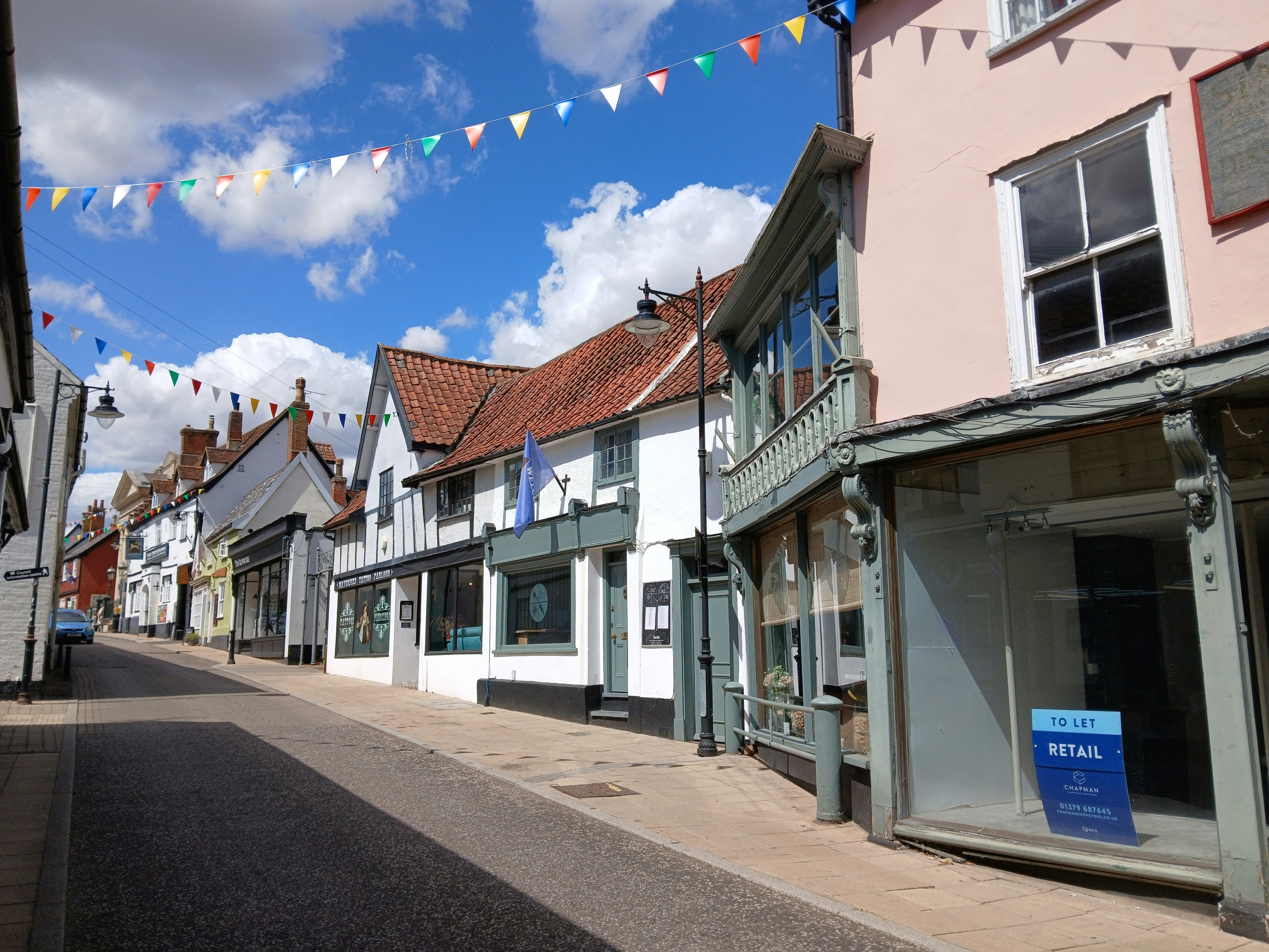 Colorful Street in Bloom: Flags, Facades, and Quiet Light
