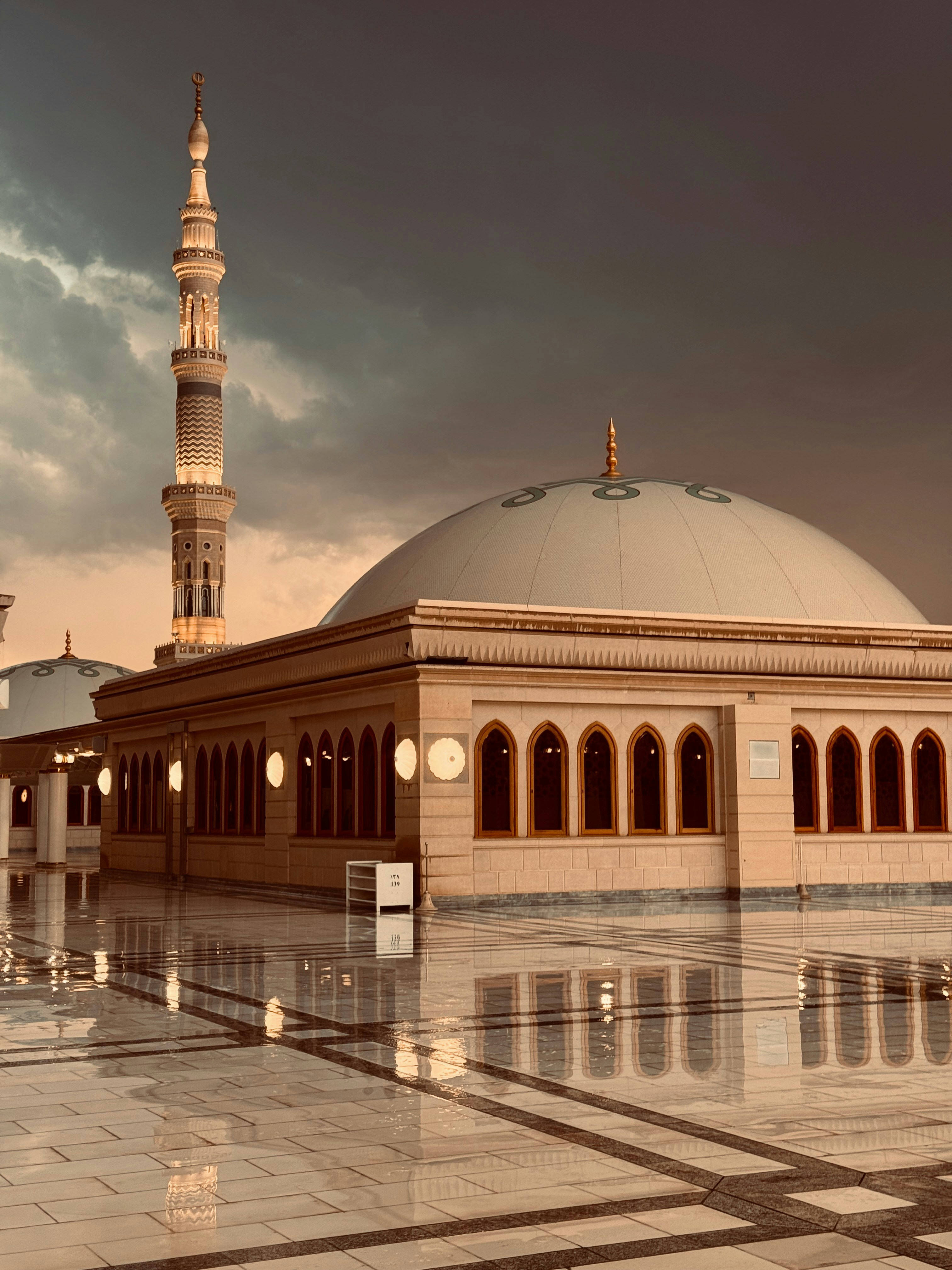 Golden Domed Grandeur: A Mosque Courtyard at Dusk