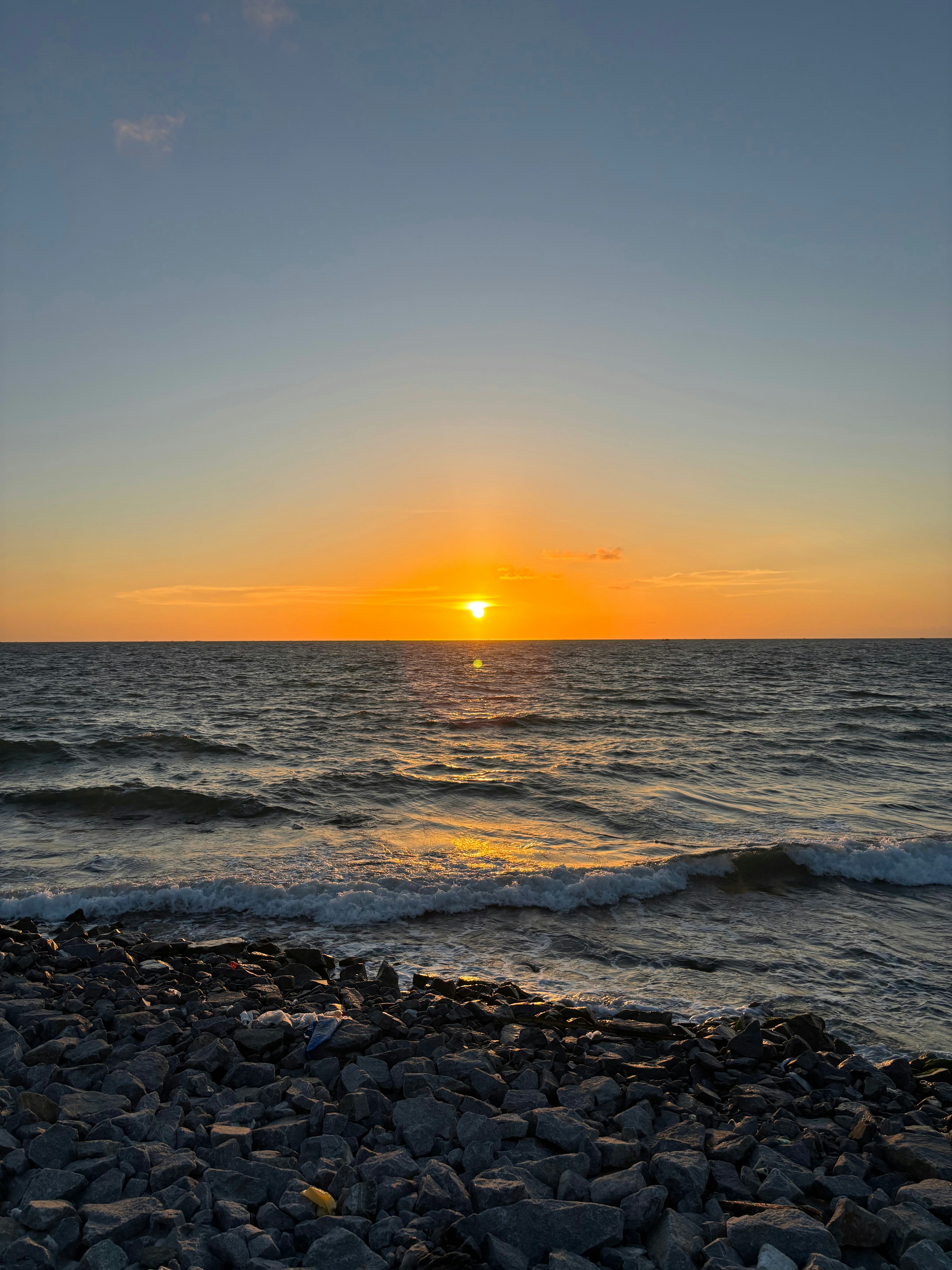 Sunlit Crest: A Quiet Ocean at Dusk