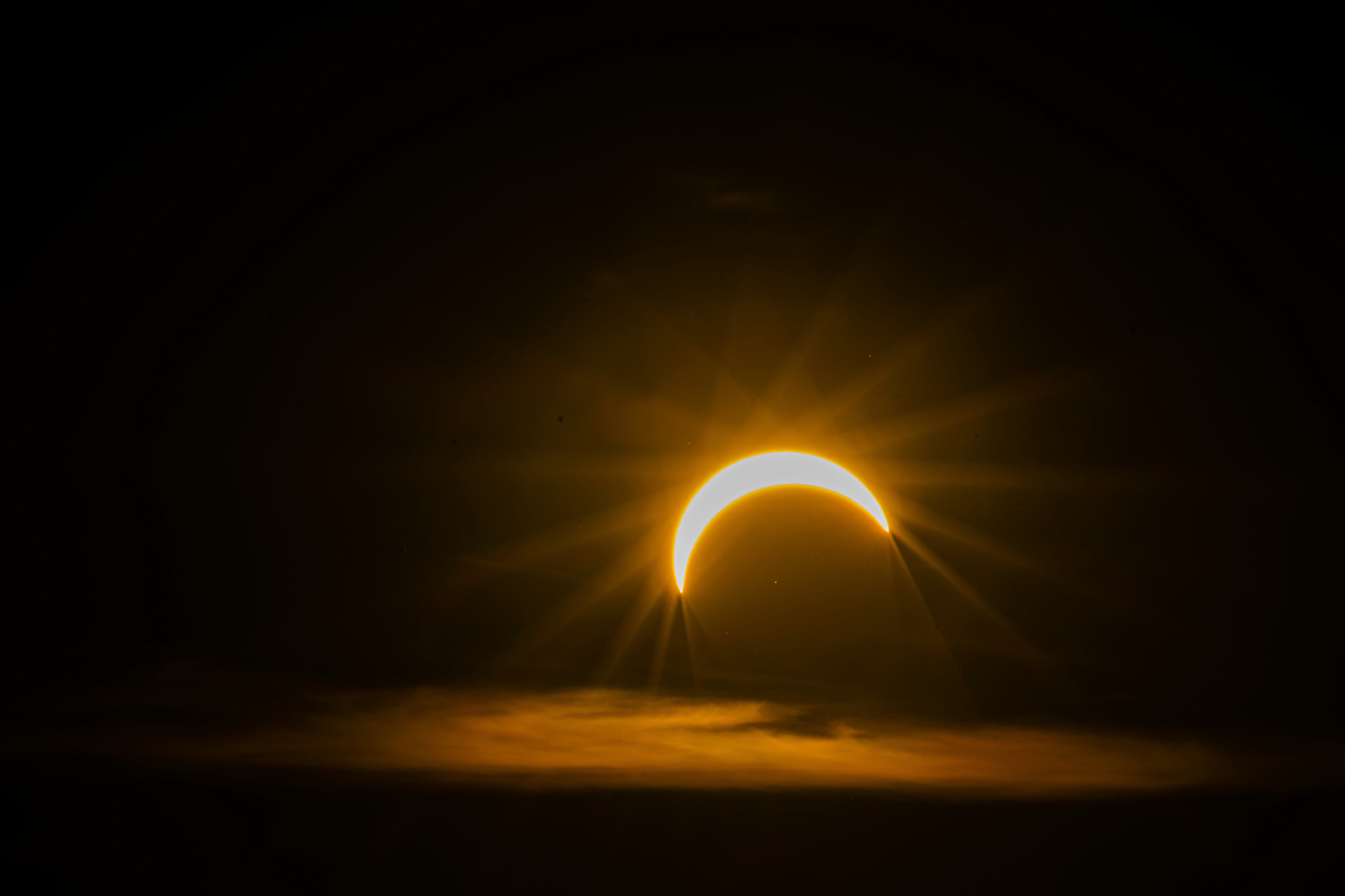 Solar Arc: The Eclipsed Crescent Above the Quiet Horizon